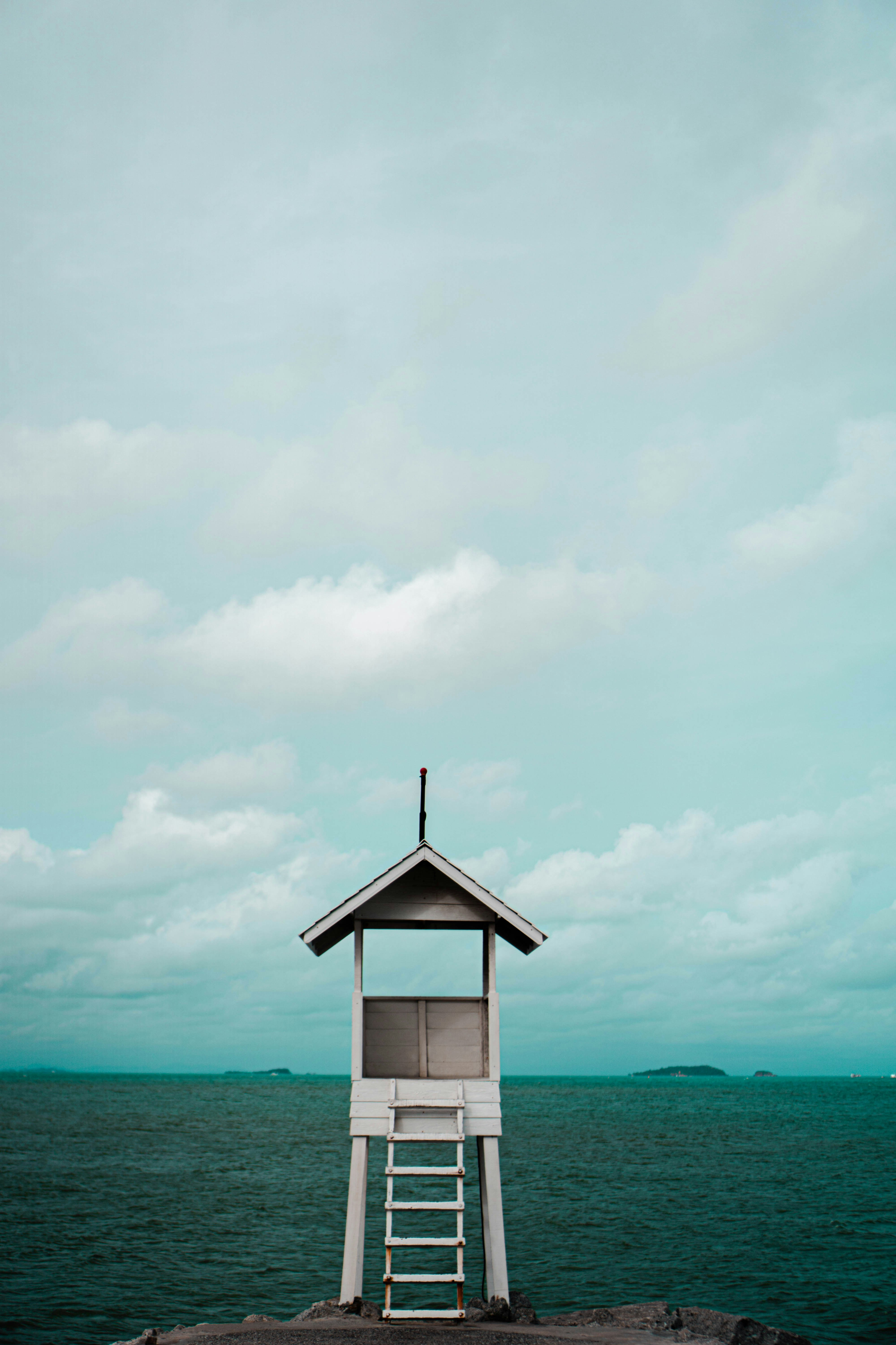 Lifeguard's Quiet Post over a Teal Sea