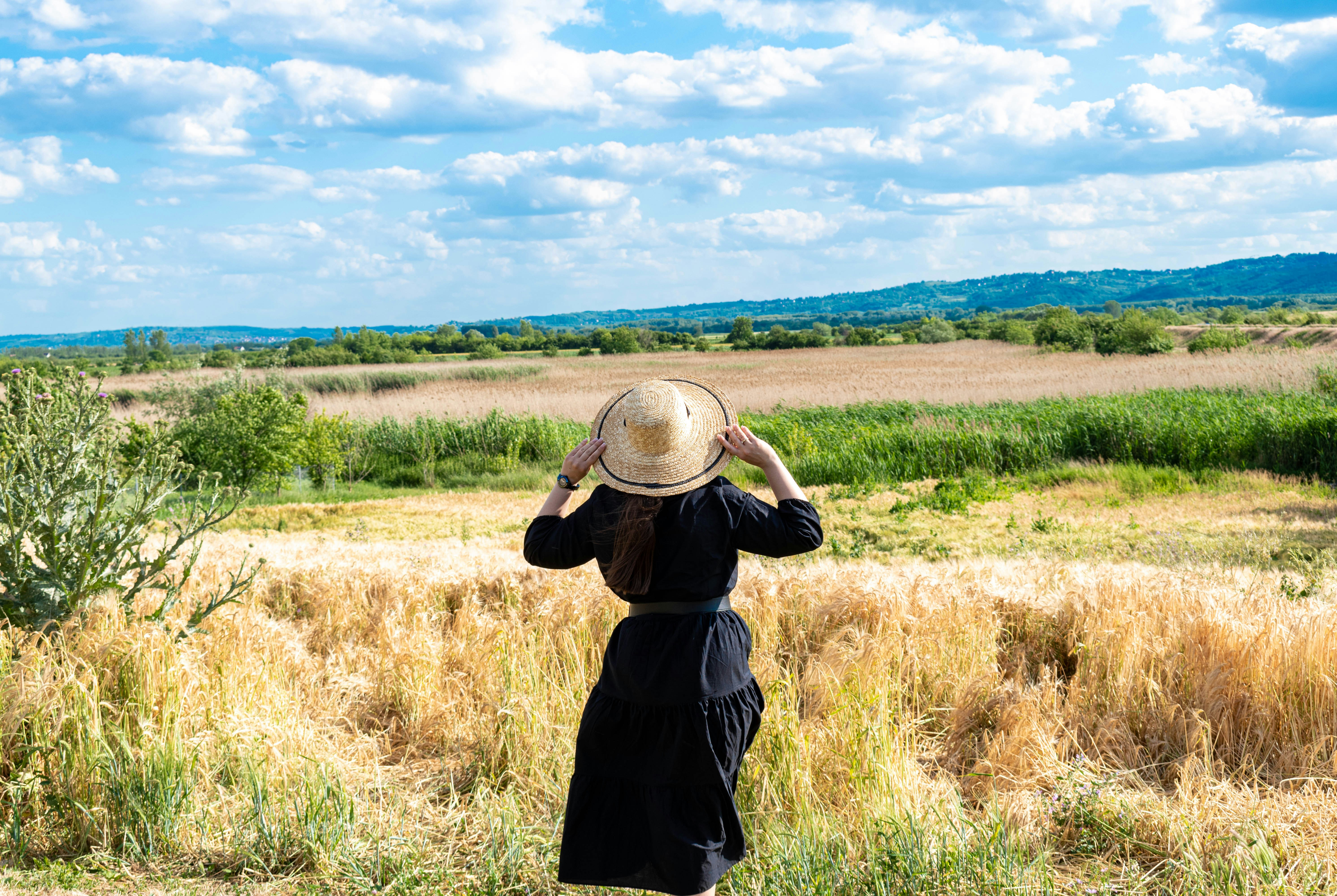 The Quiet Prairie Portrait: Hat, Dress, and Open Sky