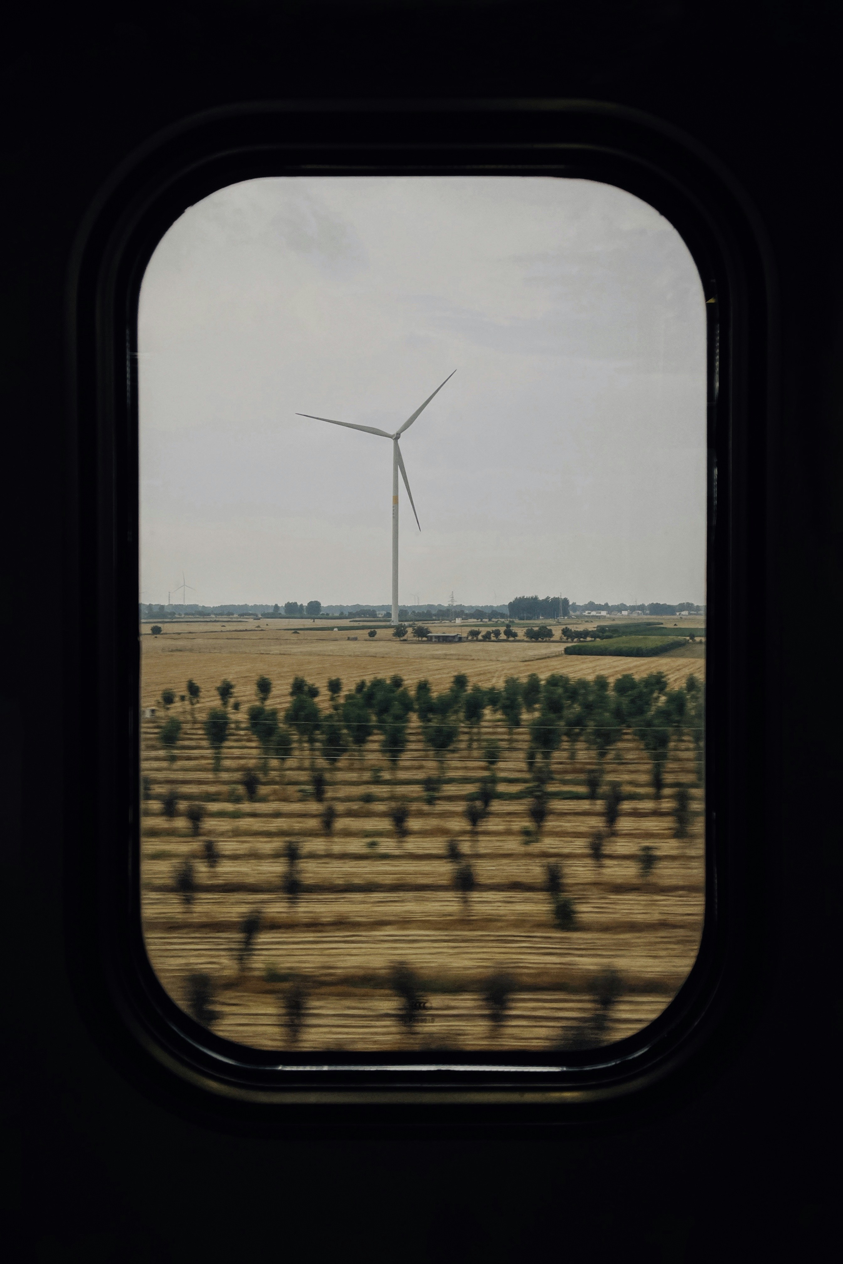 A view of a wind turbine through a window photo – Free Machine Image on ...