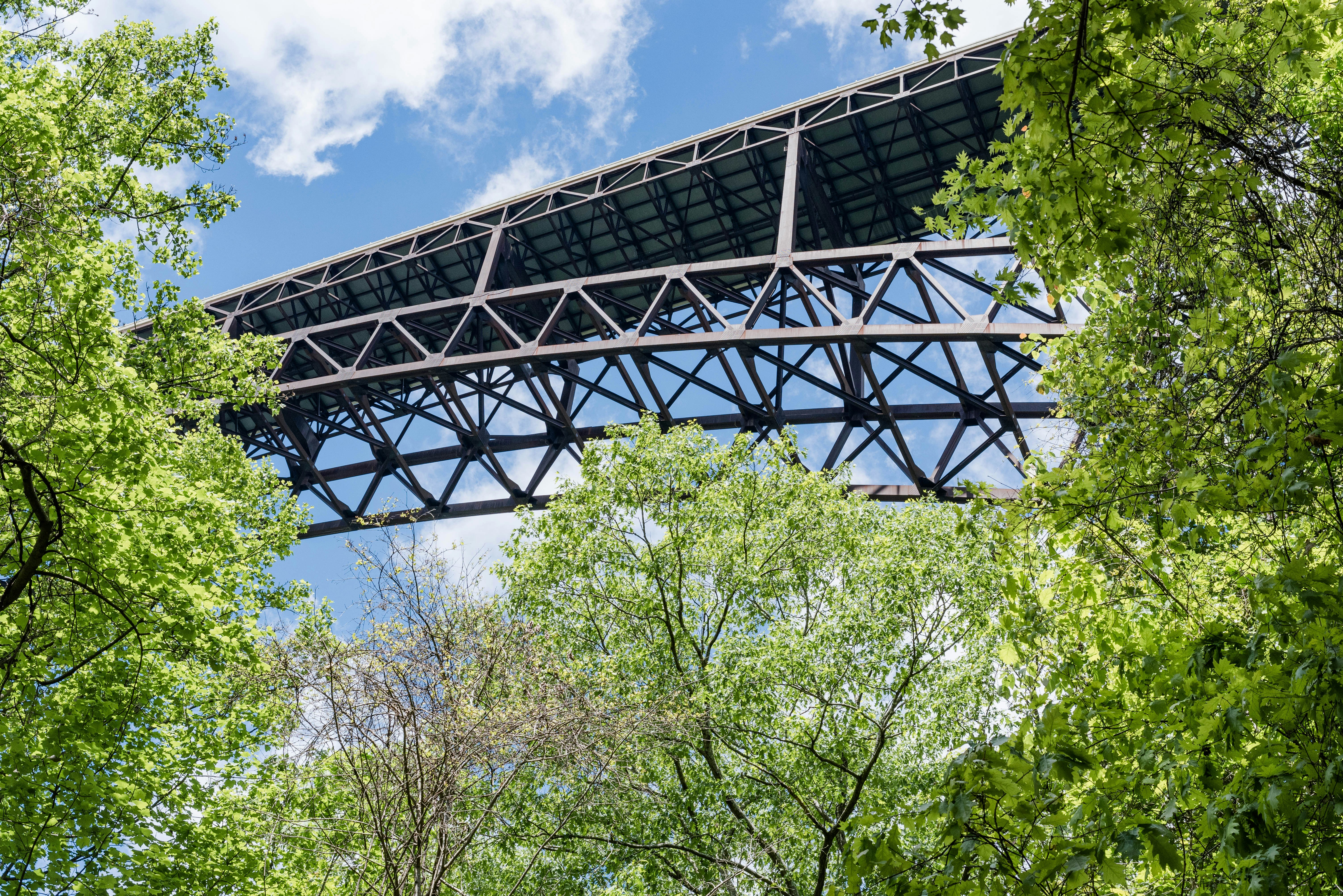 Black metal frame bridge under blue sky during daytime photo – Free New ...