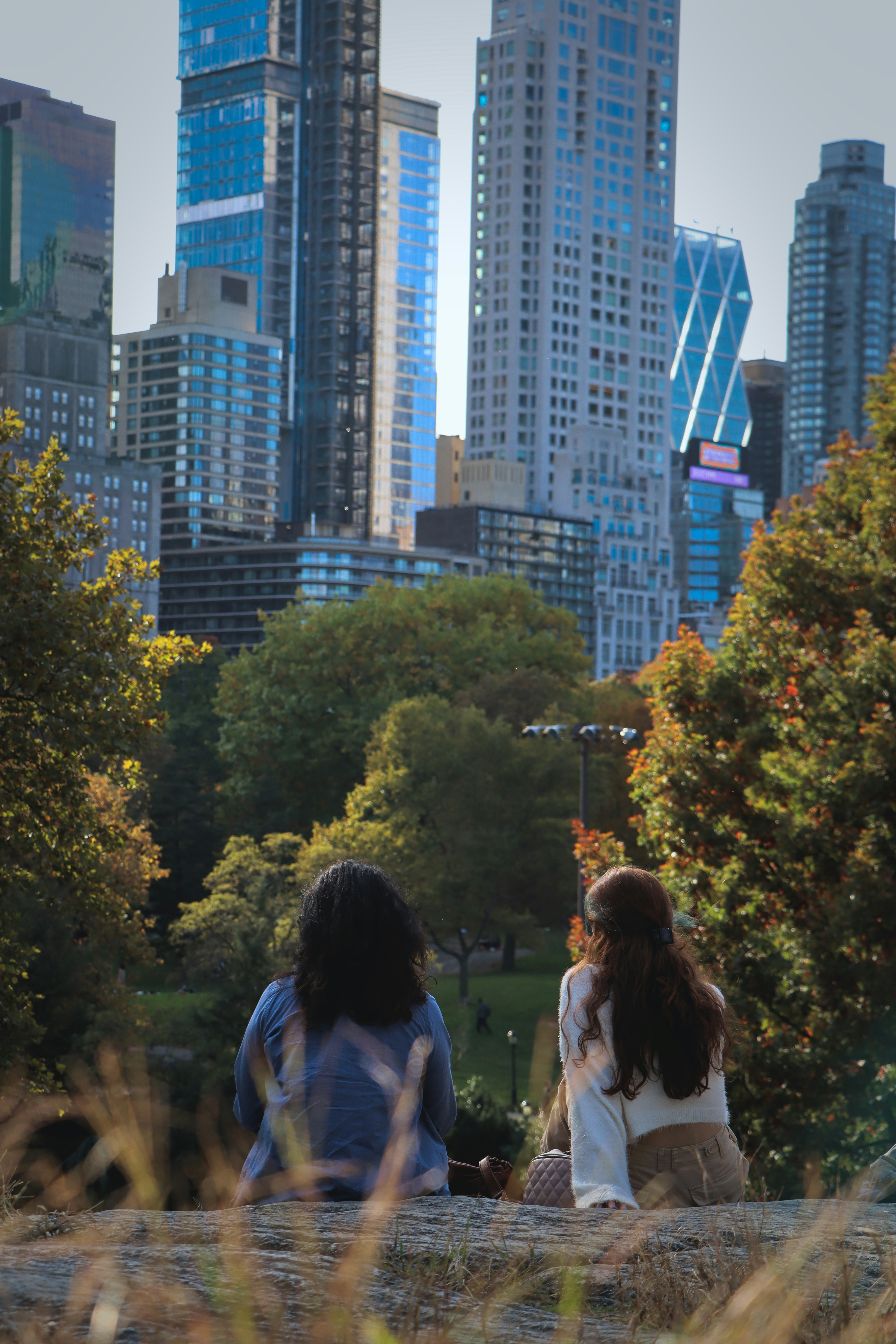 People walking on sidewalk near high rise buildings during daytime ...