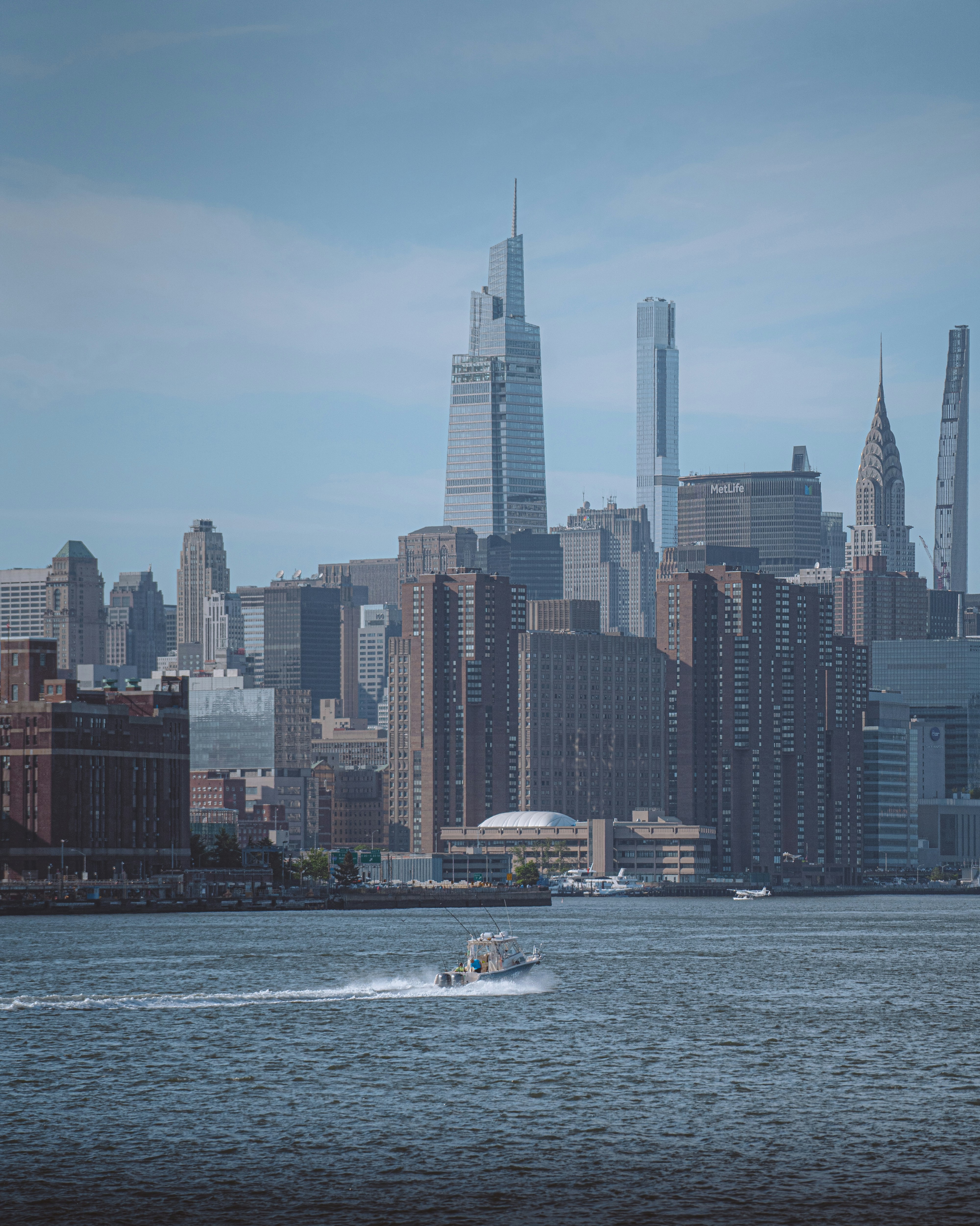 Spires and Wake: A Ferry Tracing the City Skyline