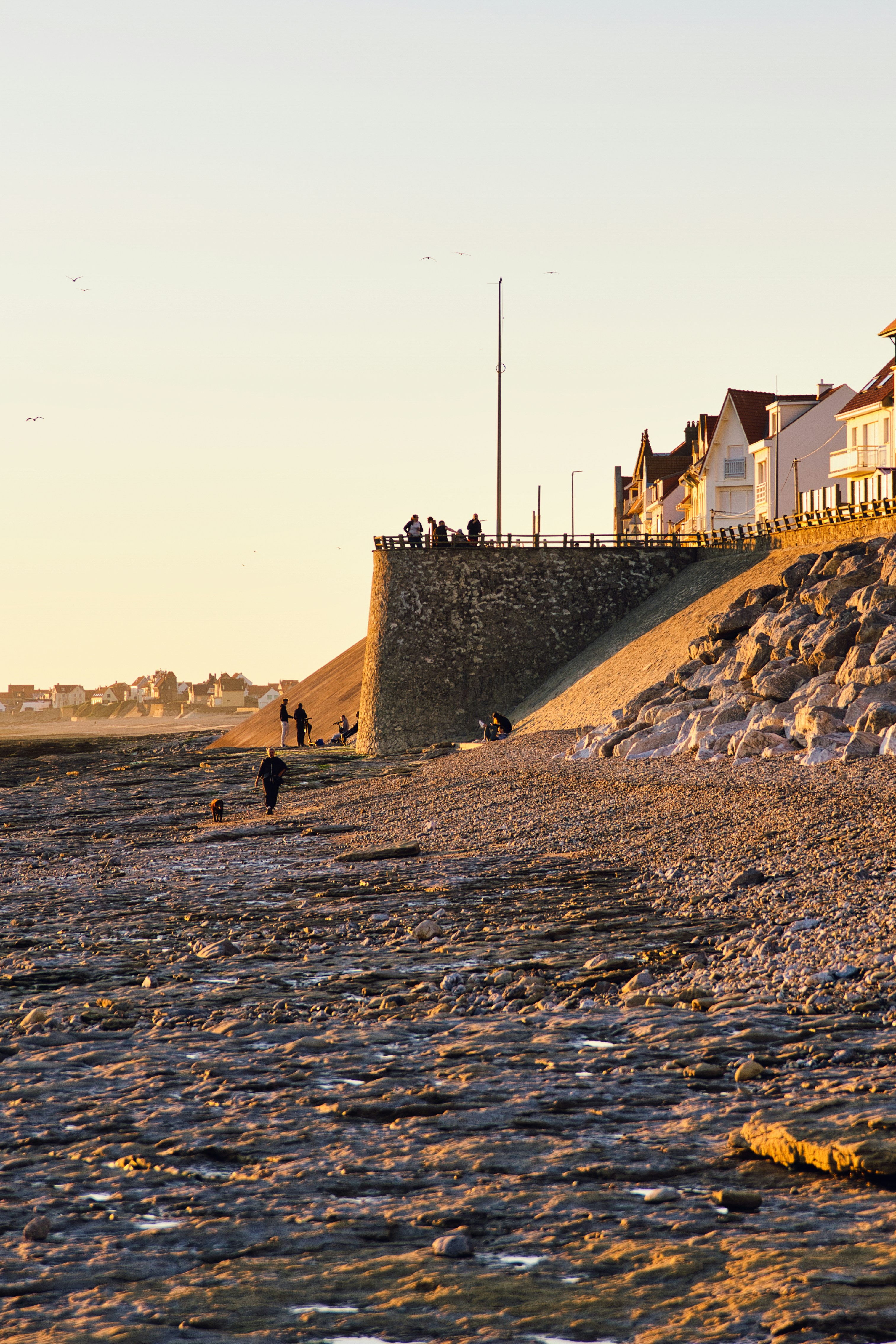 Sunlit Promenade: A Coastal Esplanade Framed by a Cliffside Village