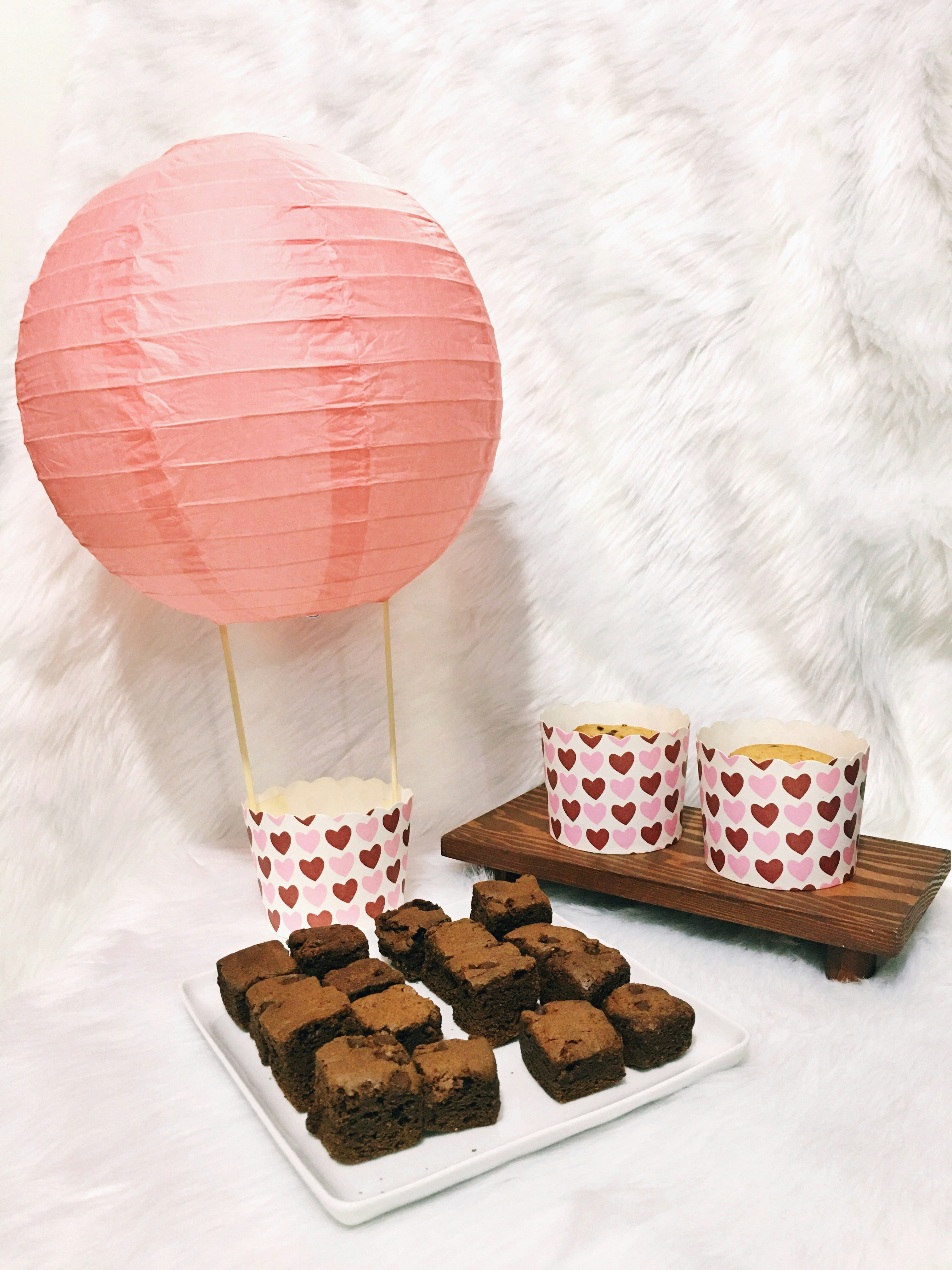 Pink Lantern Balloon Over Cocoa Squares and Heart Cups