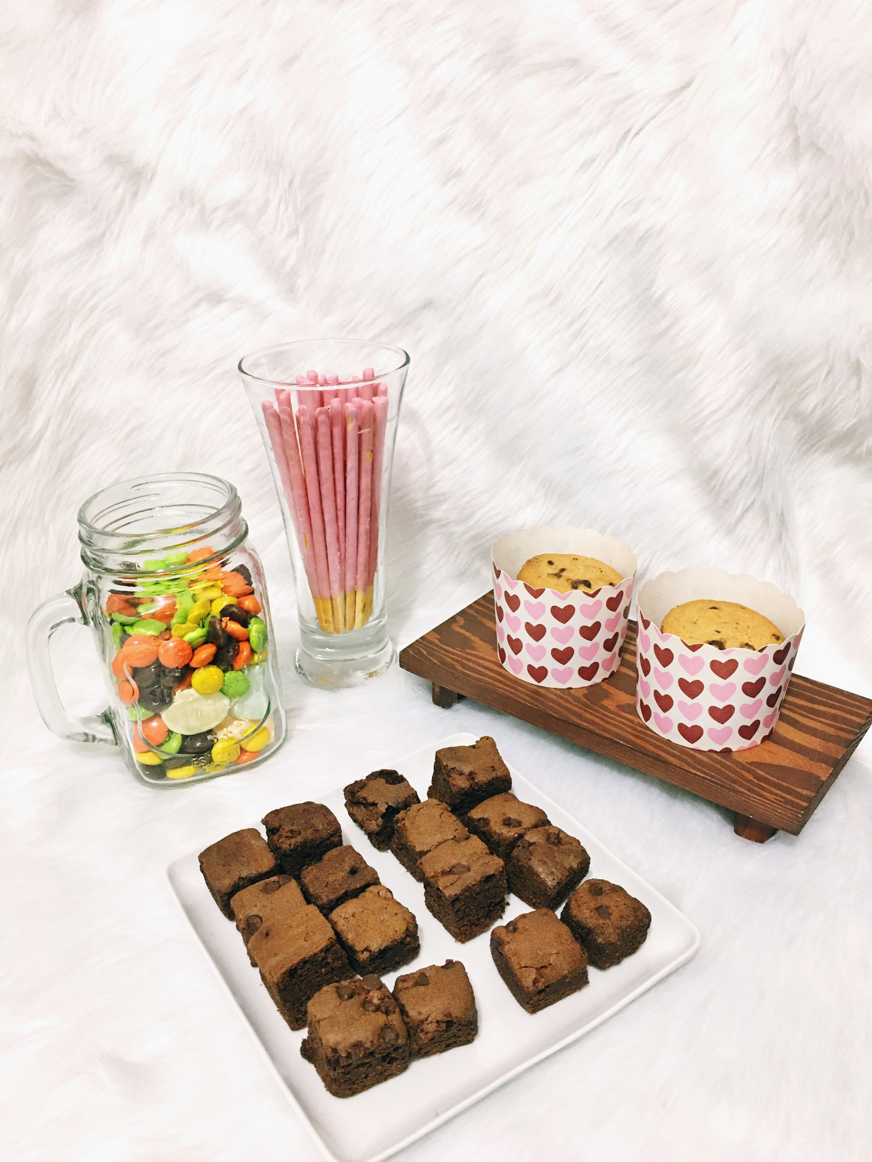 Pastel Dessert Ensemble: Brownie Squares, Cupcakes, and Candy Jar