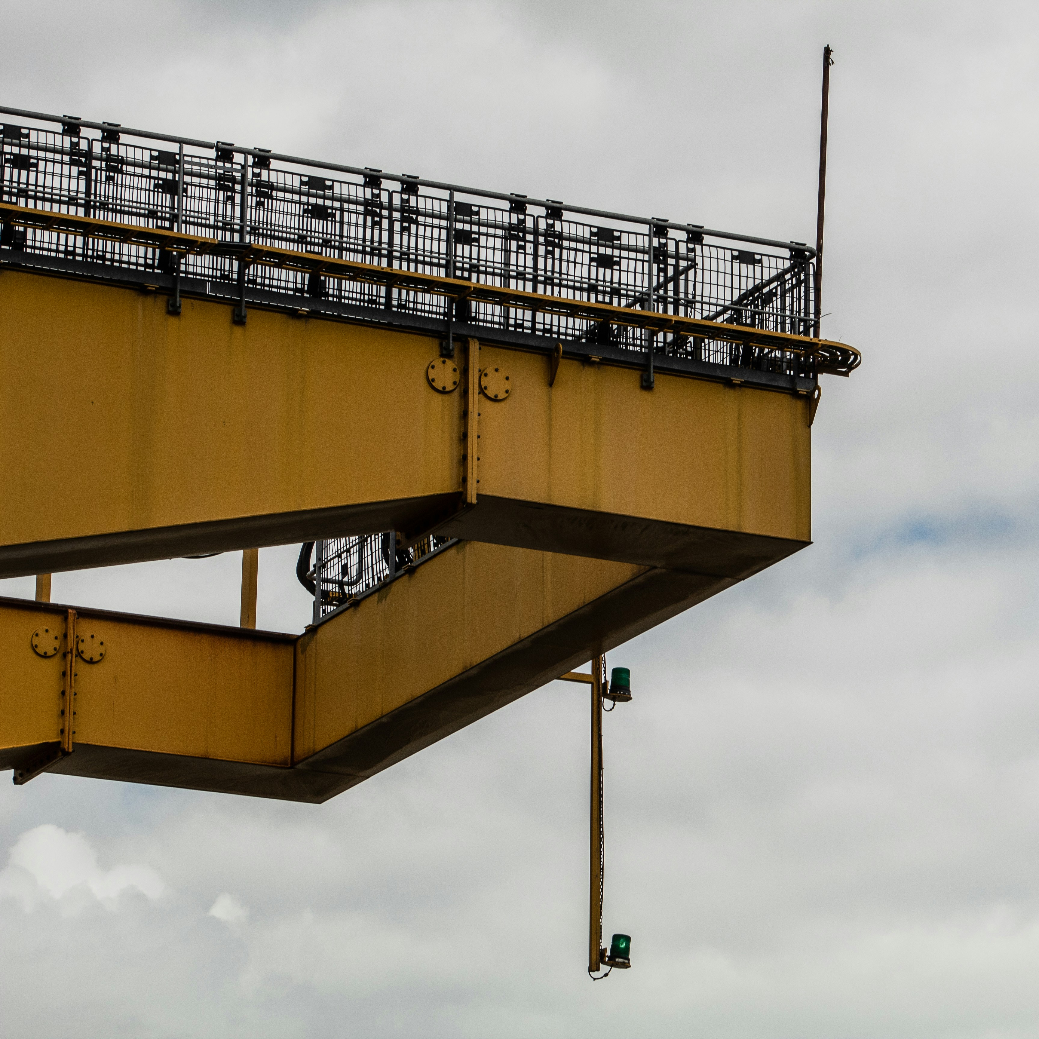 Yellow Crossbeam in the Sky: Industrial Geometry in a Cloudy Horizon
