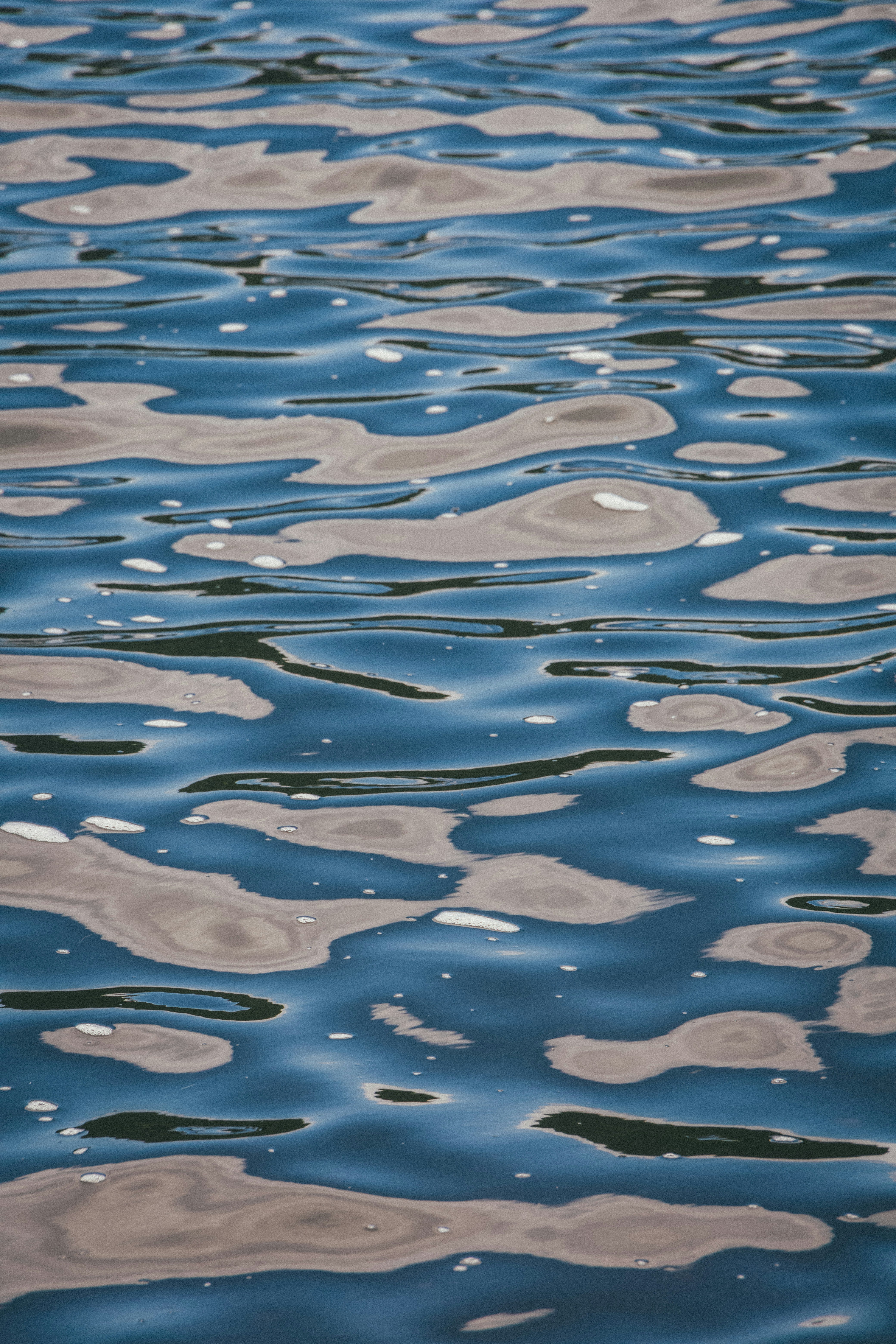 Ripple Mosaic: Sunlit Blue Reflections on Water
