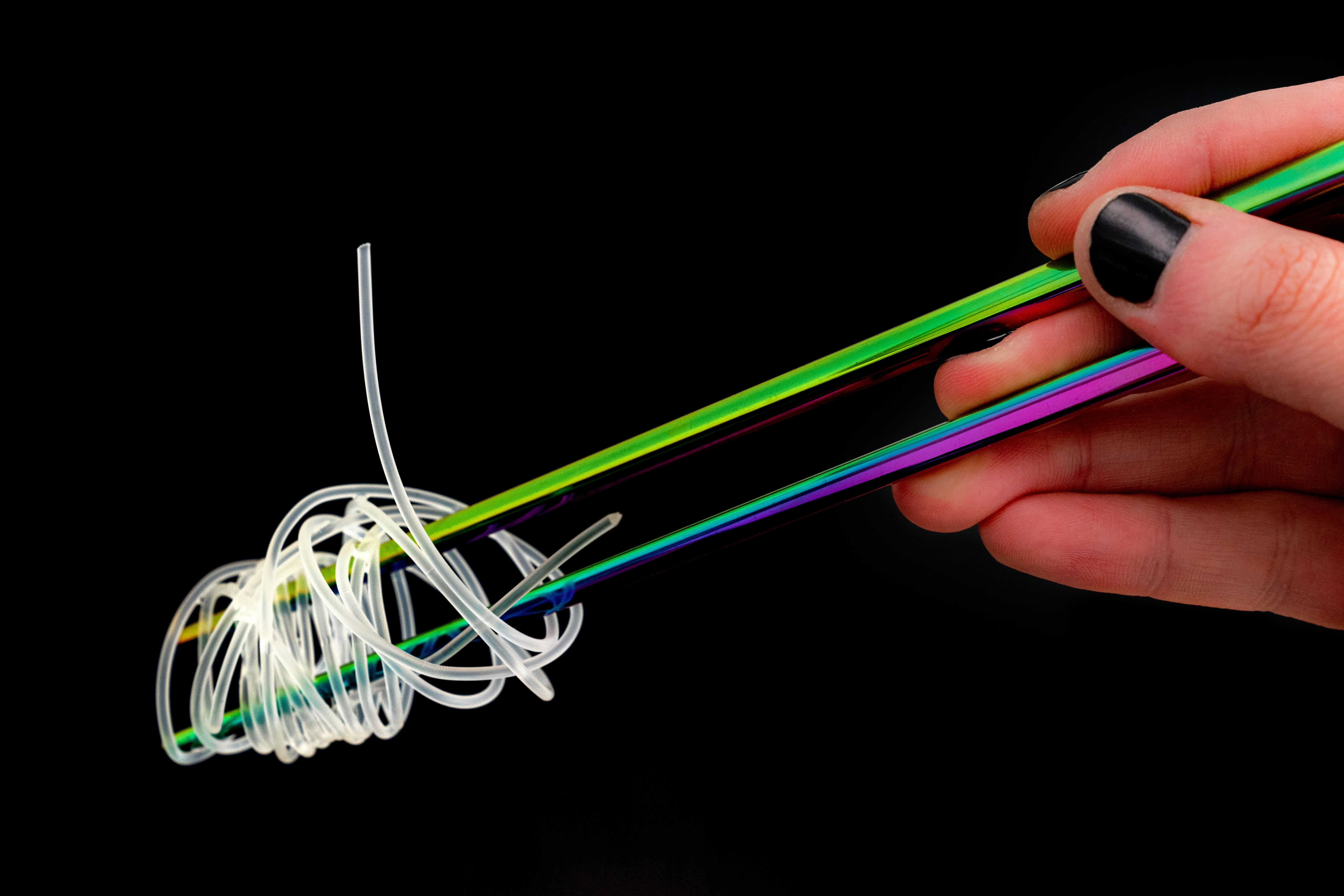 Neon Threads Unravel Under a Delicate Grip