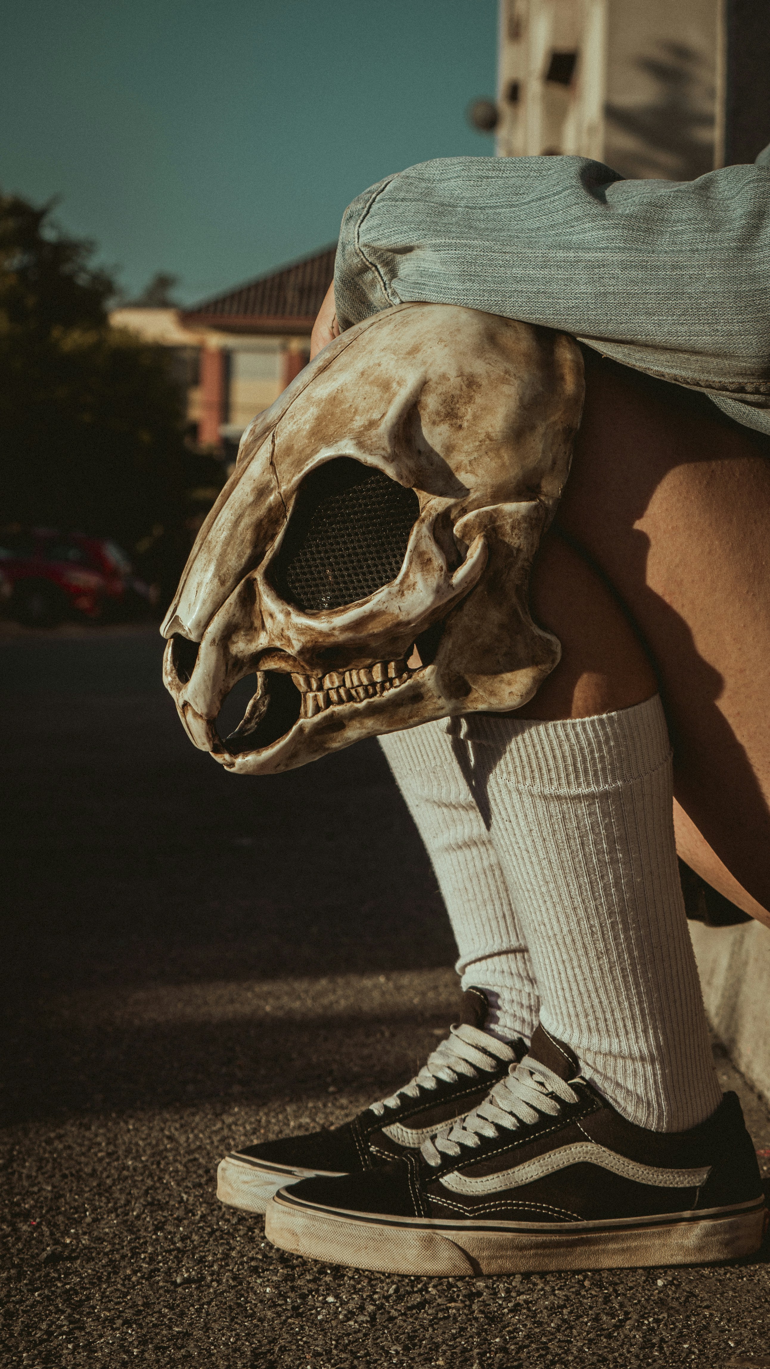 Skull Mask and Vans: A Quiet Street Portrait in Warm Tones