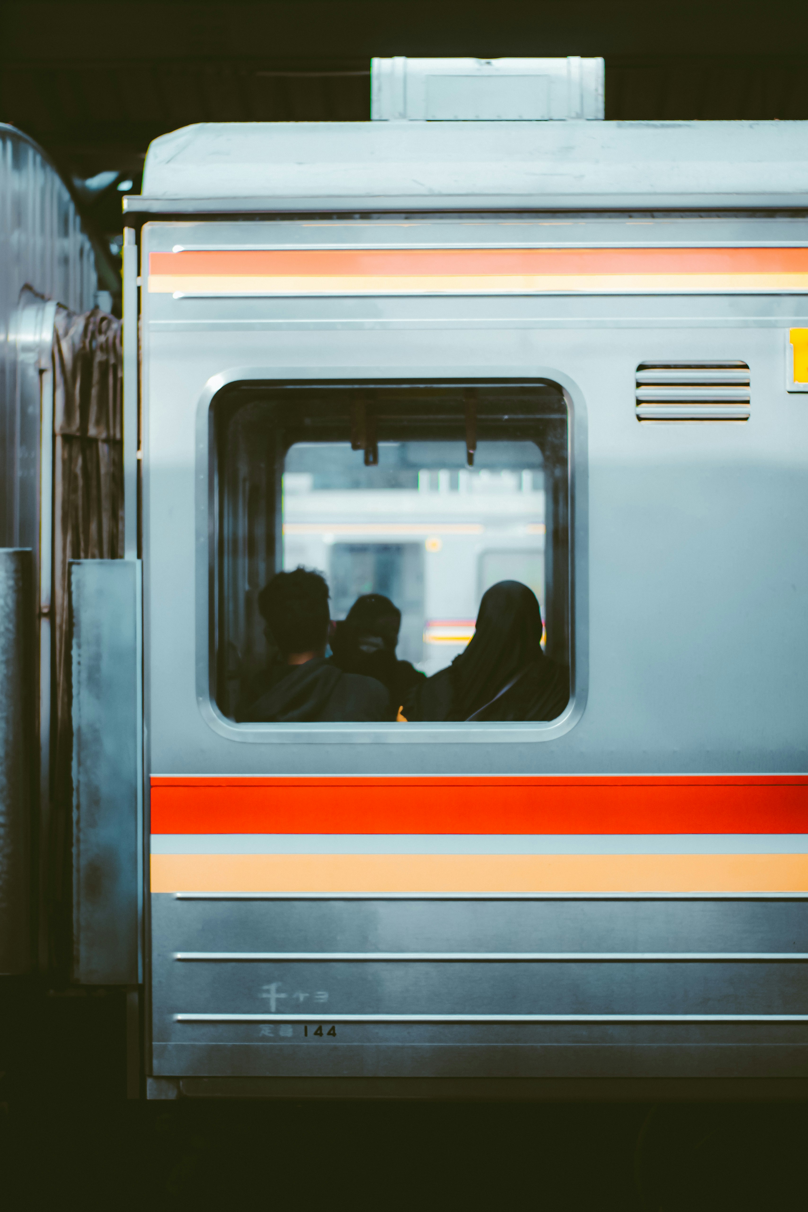 Man in black jacket sitting on train photo – Free Train station Image ...