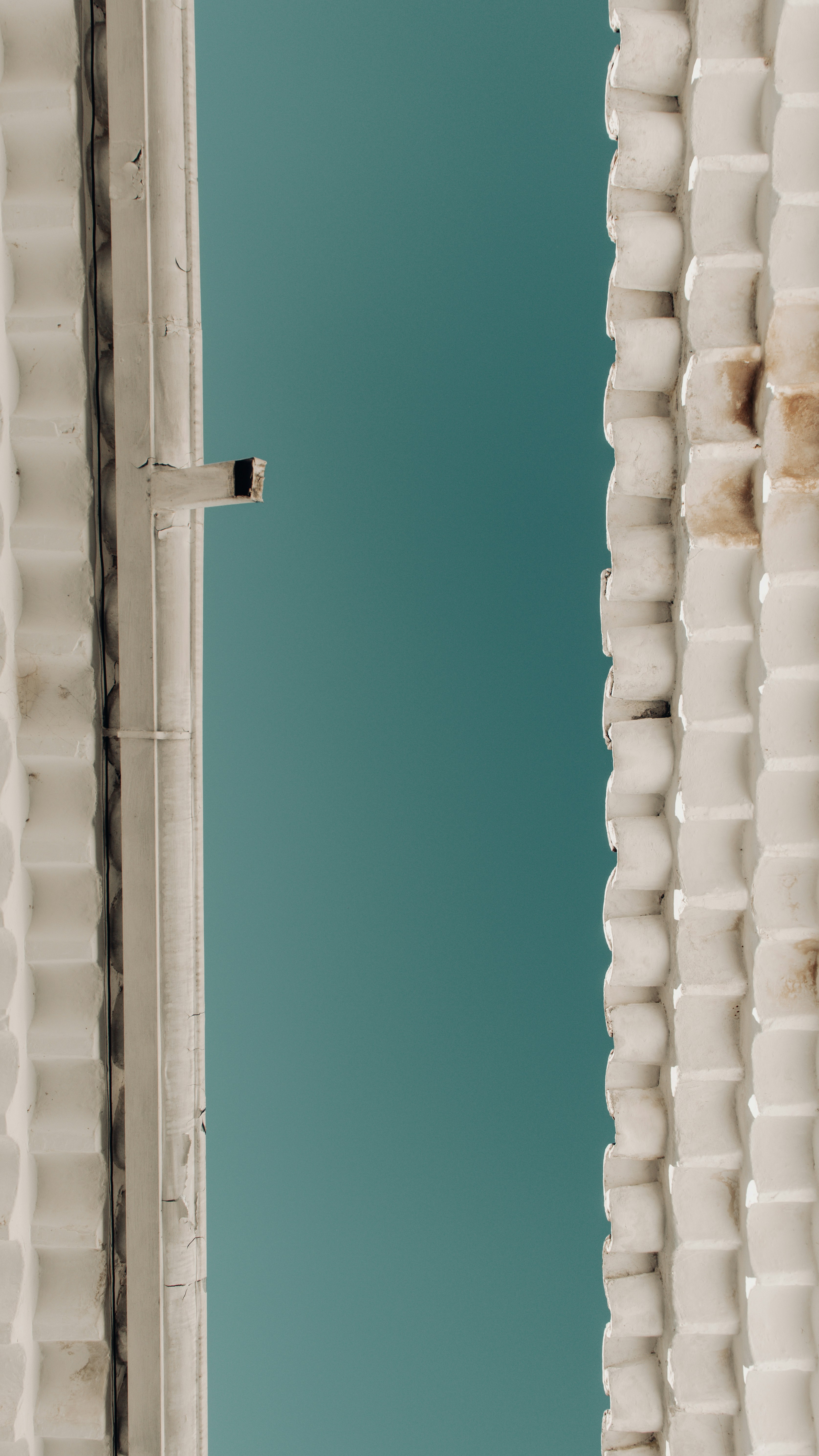 Teal Gap Between White Facades