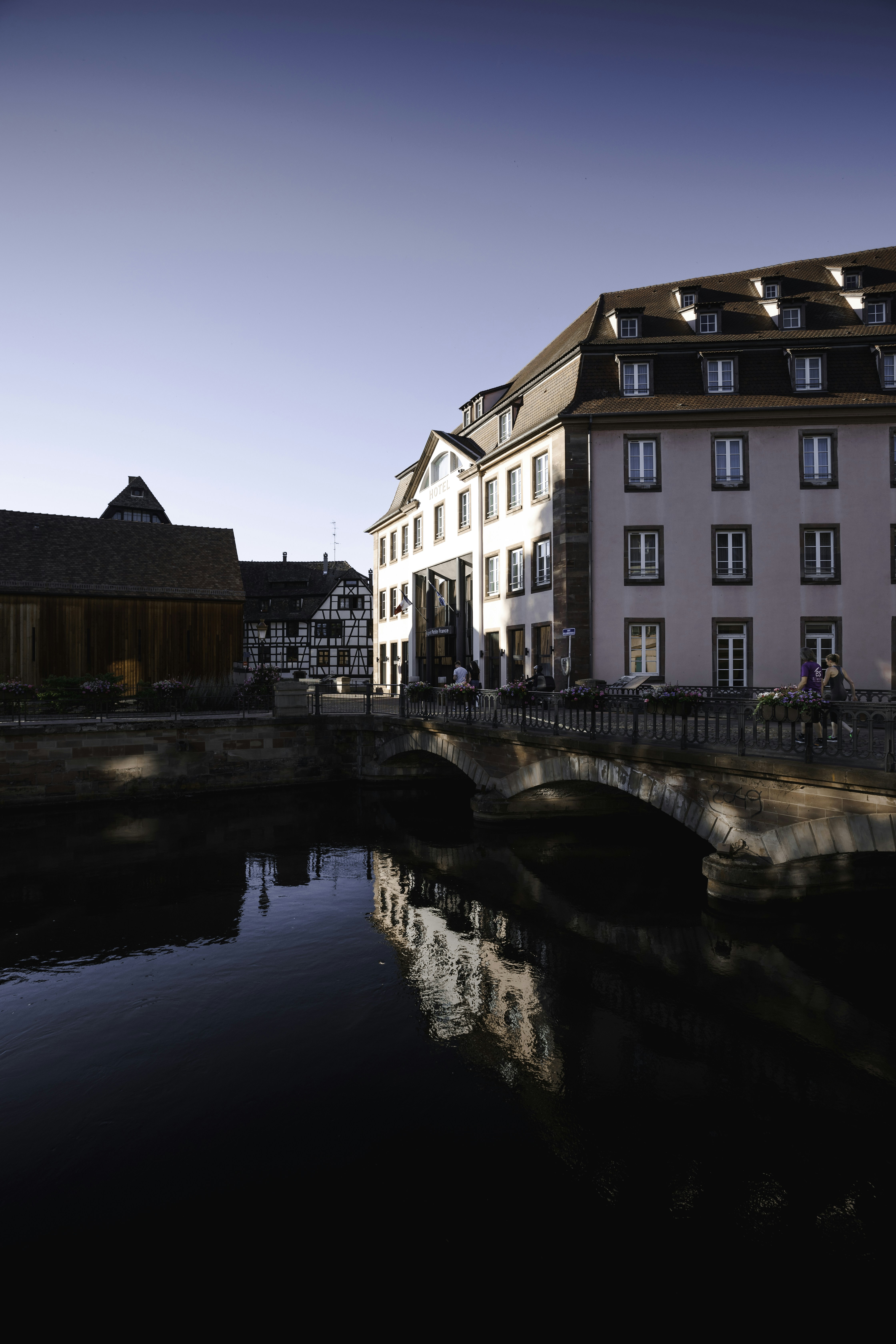 Sunlit Facade Overlooking a Quiet Germanic Bridge