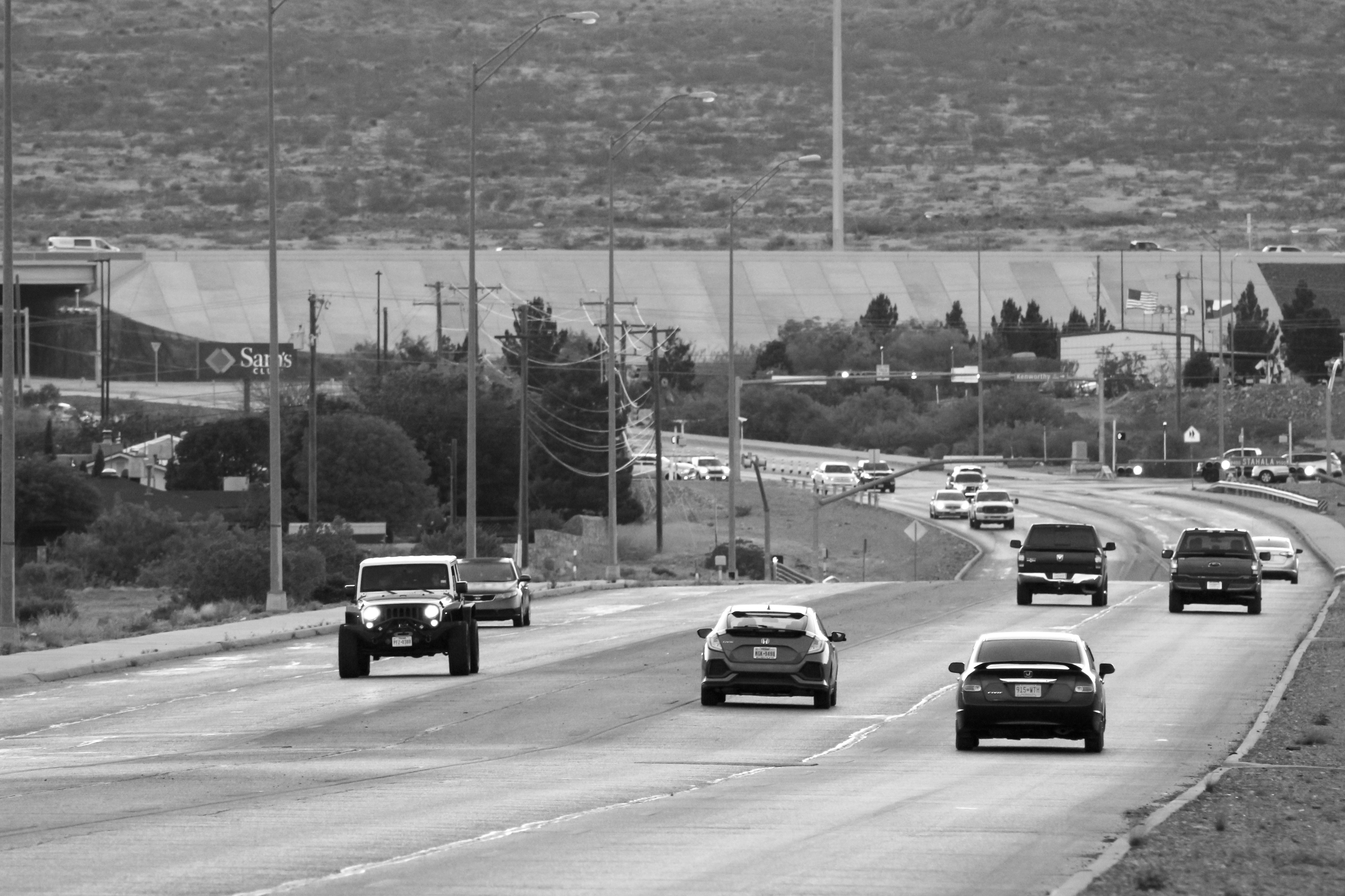 grayscale photo of cars on road