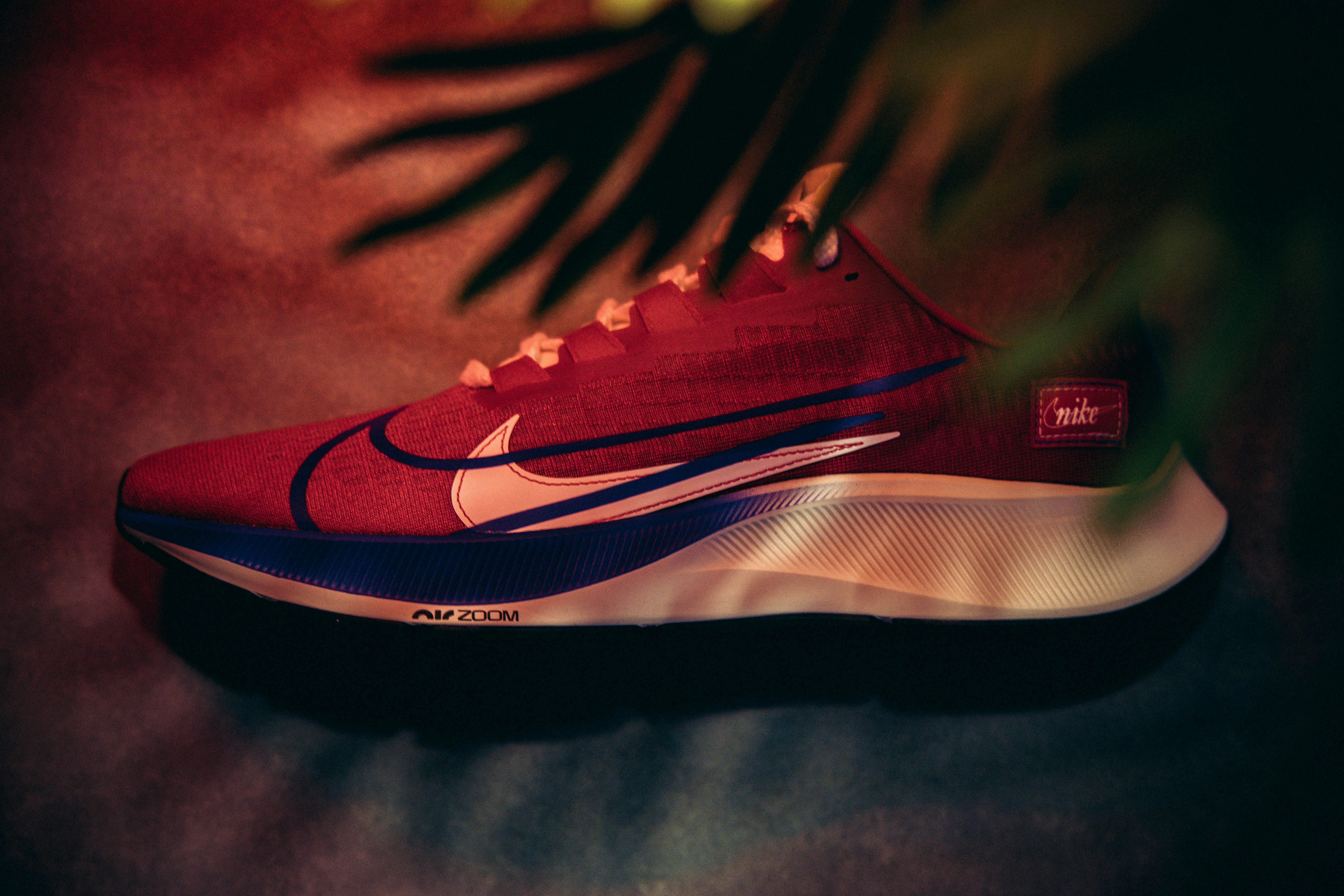 Nike running shoe showcased against a moody backdrop, highlighting its sleek design and vibrant colors.