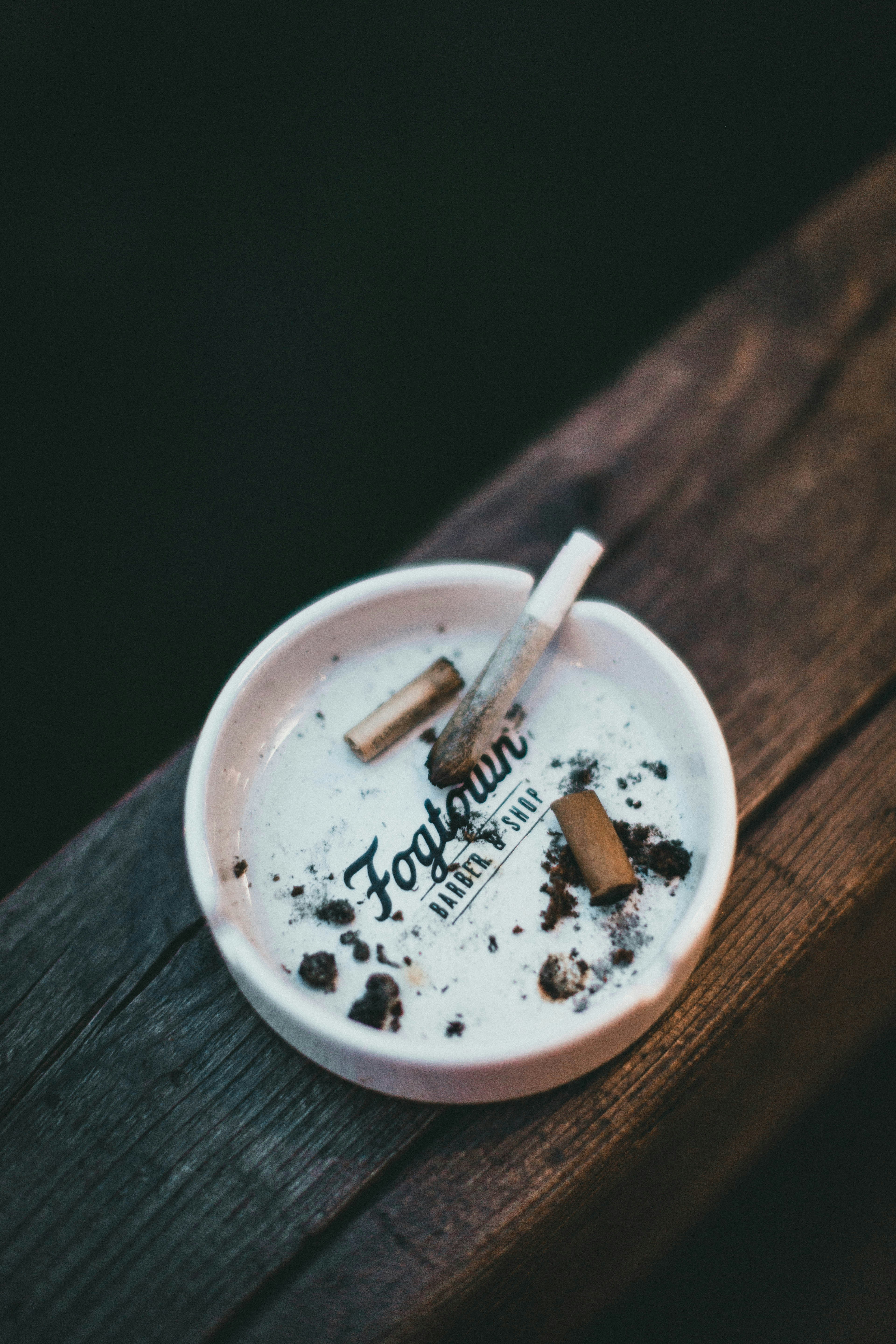 Ashes to Quiet: Cigarette Ashtray on Weathered Wood