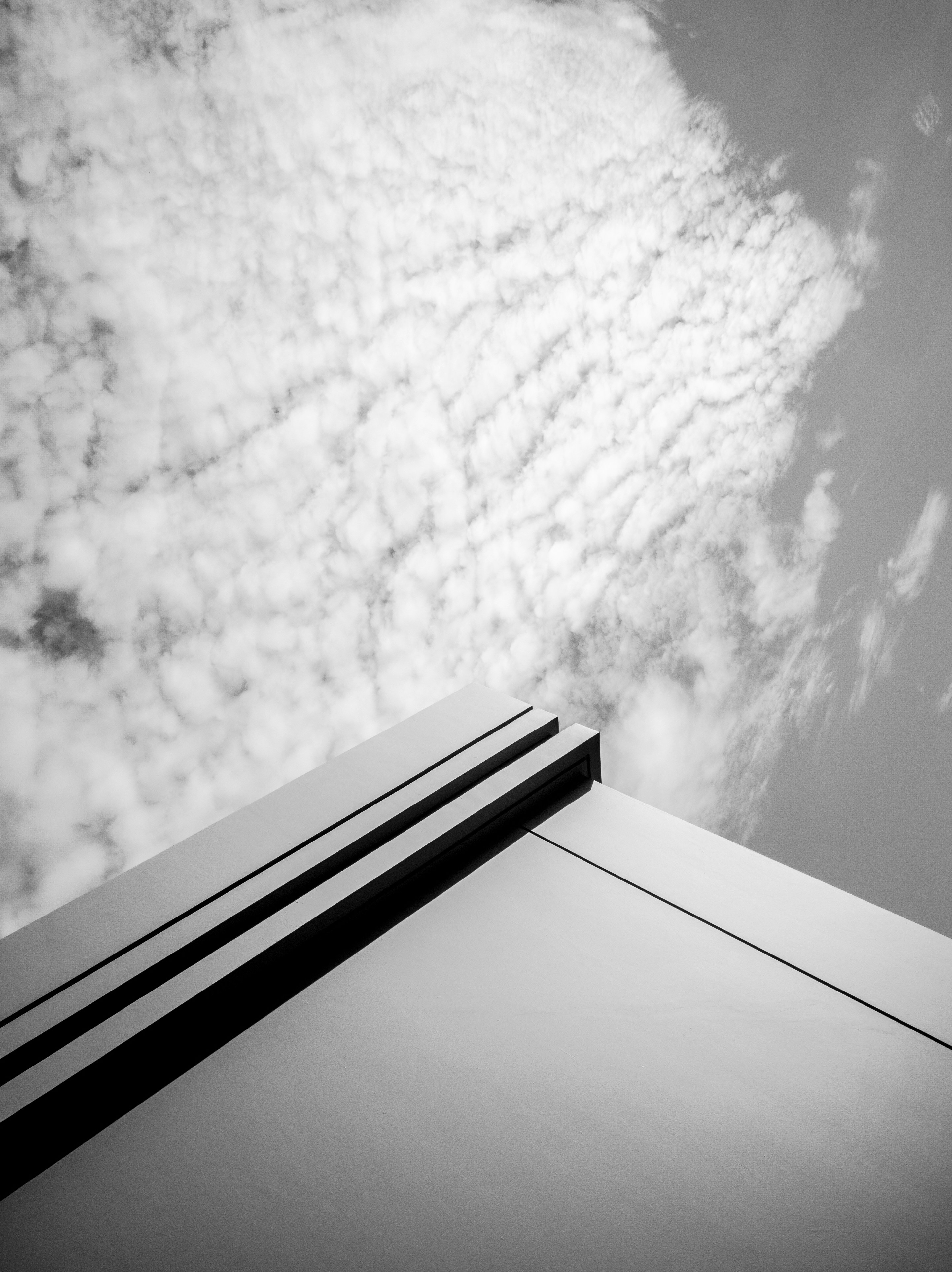 Architectural Ascension: A Black-and-White Convergence of Sky and Steel