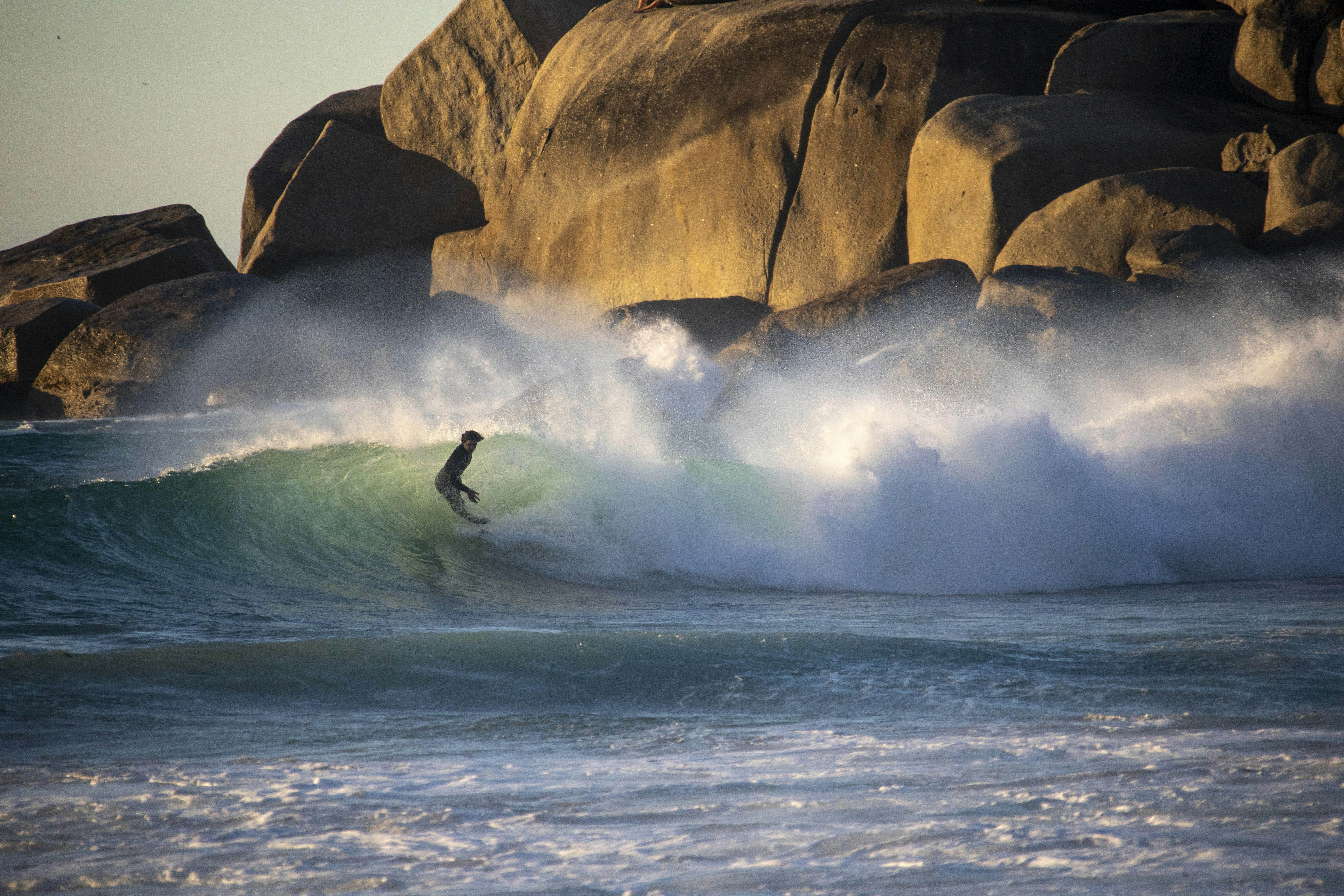 Surfer wiping out in the barrel of a wave. | person surfing on sea waves during daytime