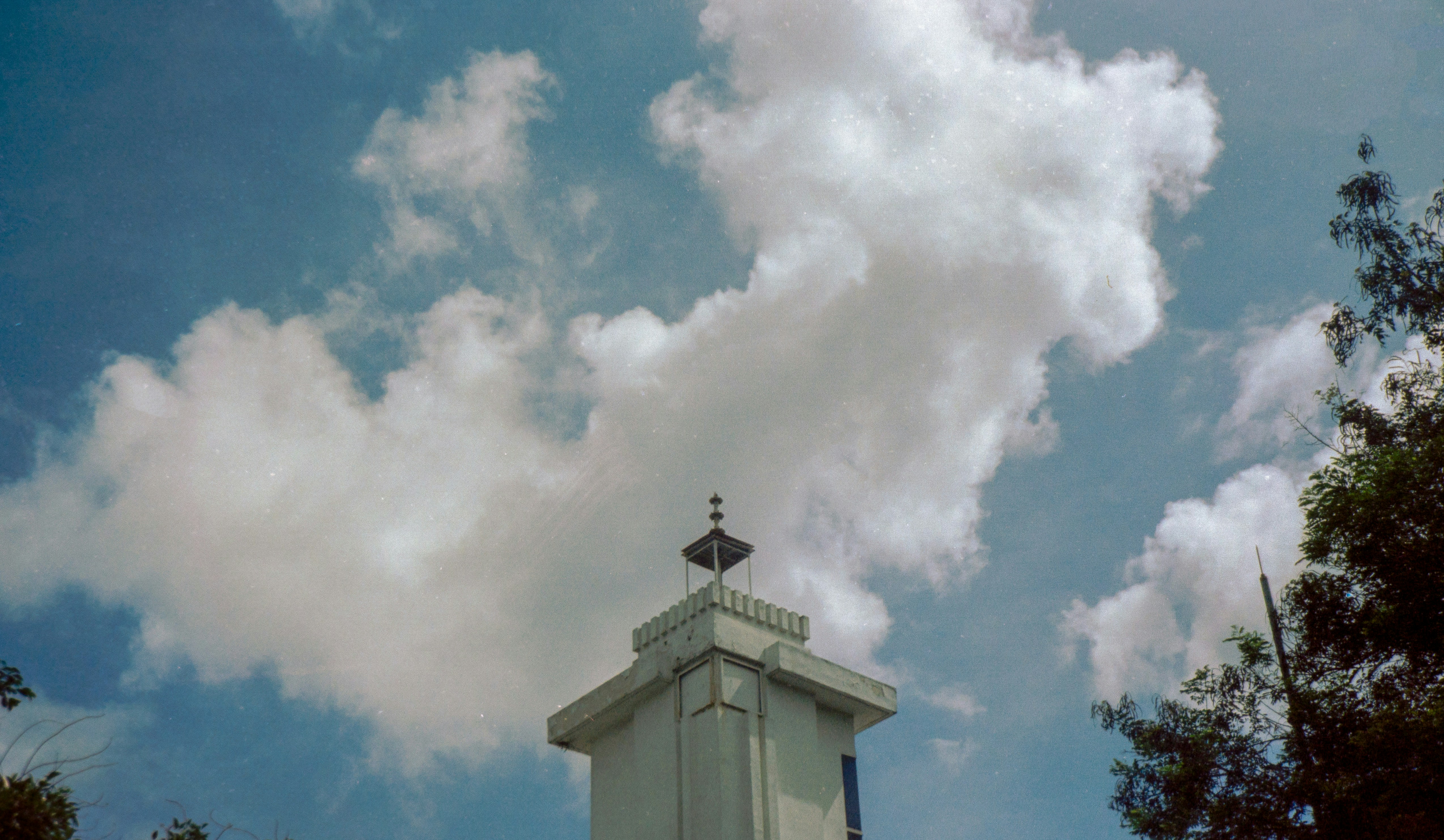 Cloud-Top Beacon: The White Tower Reaching Into a Wide Sky