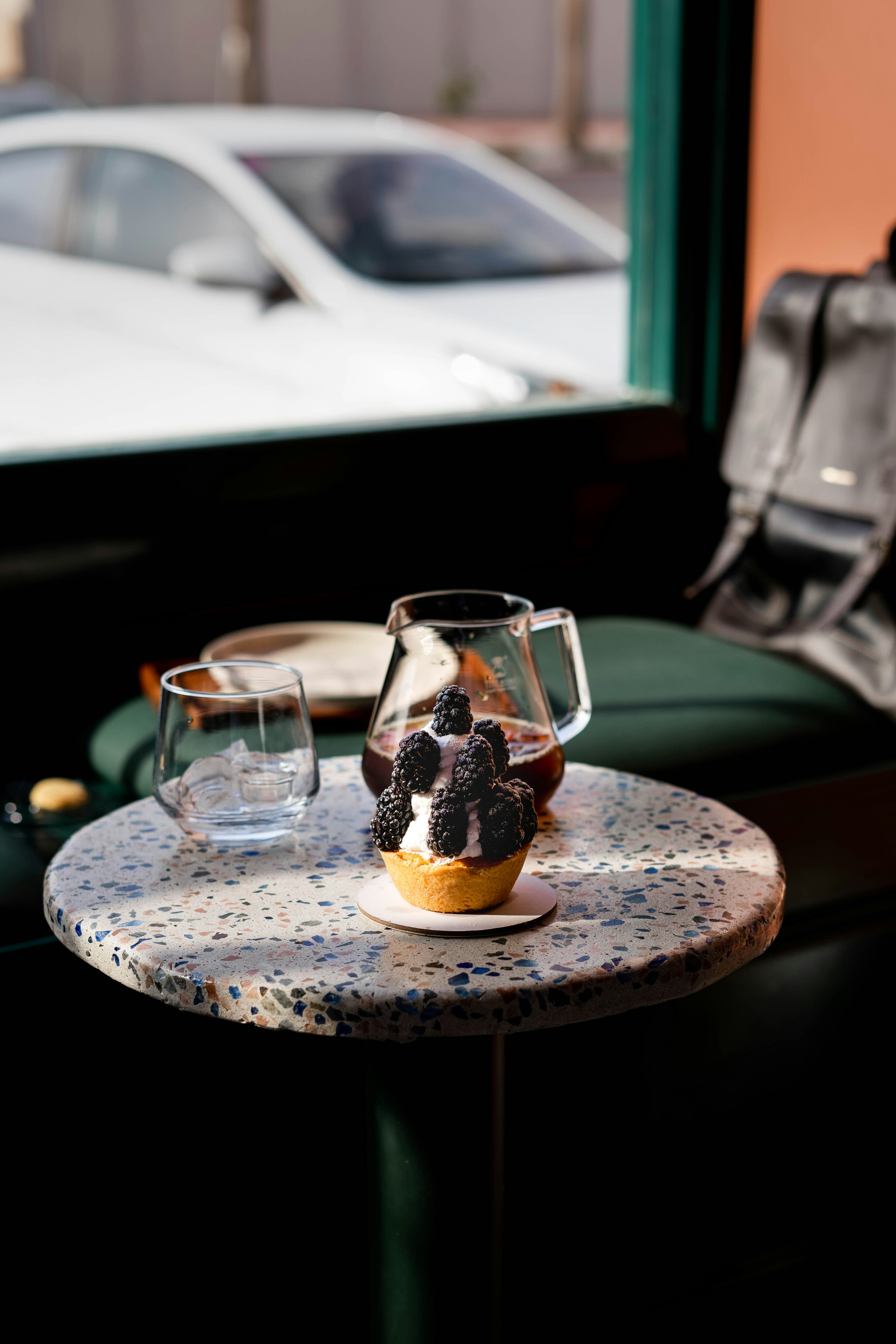 Terrazzo Table Treat: Blueberry-Stacked Pastry Under Glass Carafe