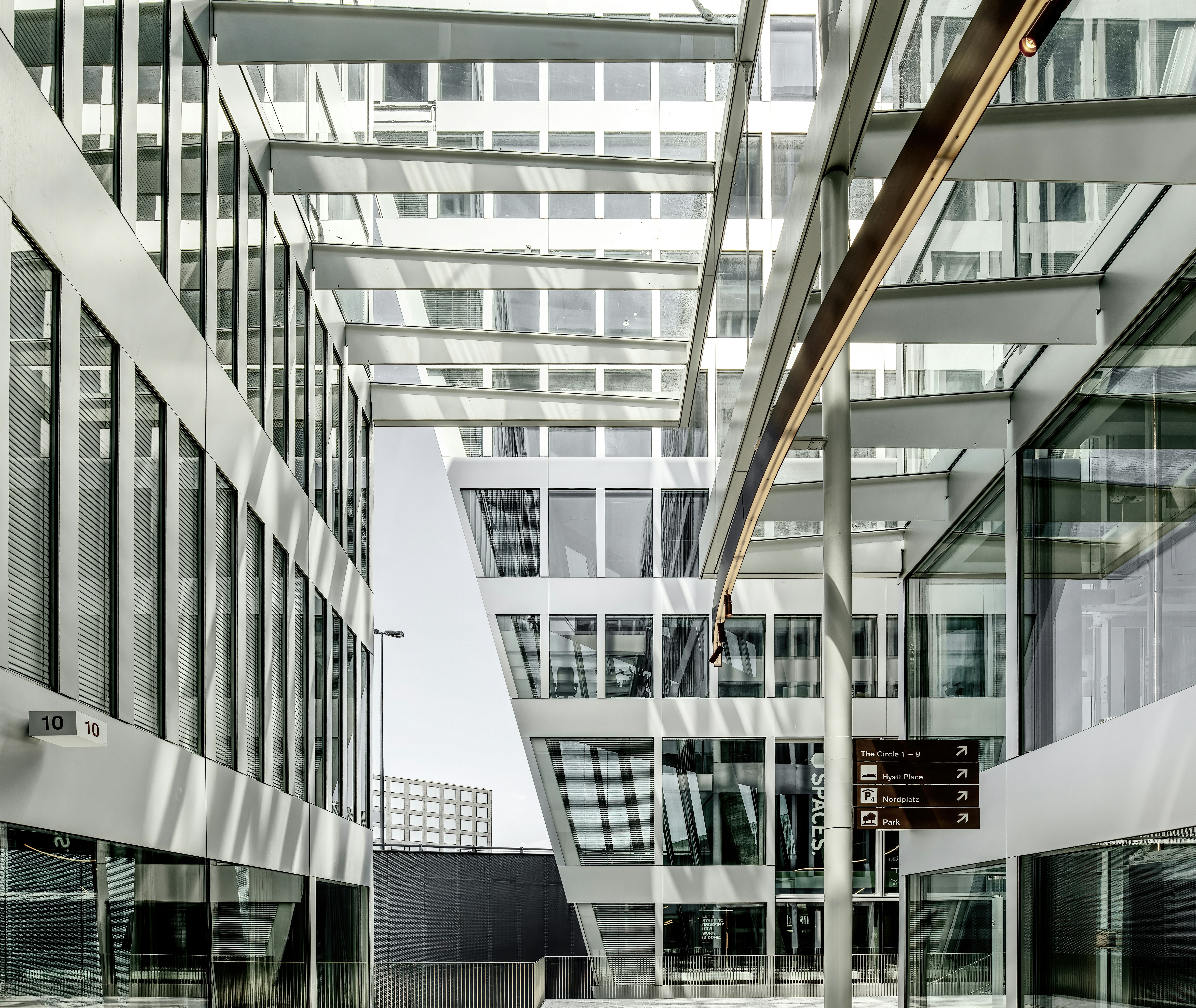 Modern architectural design with glass facades and geometric lines in an airport complex.