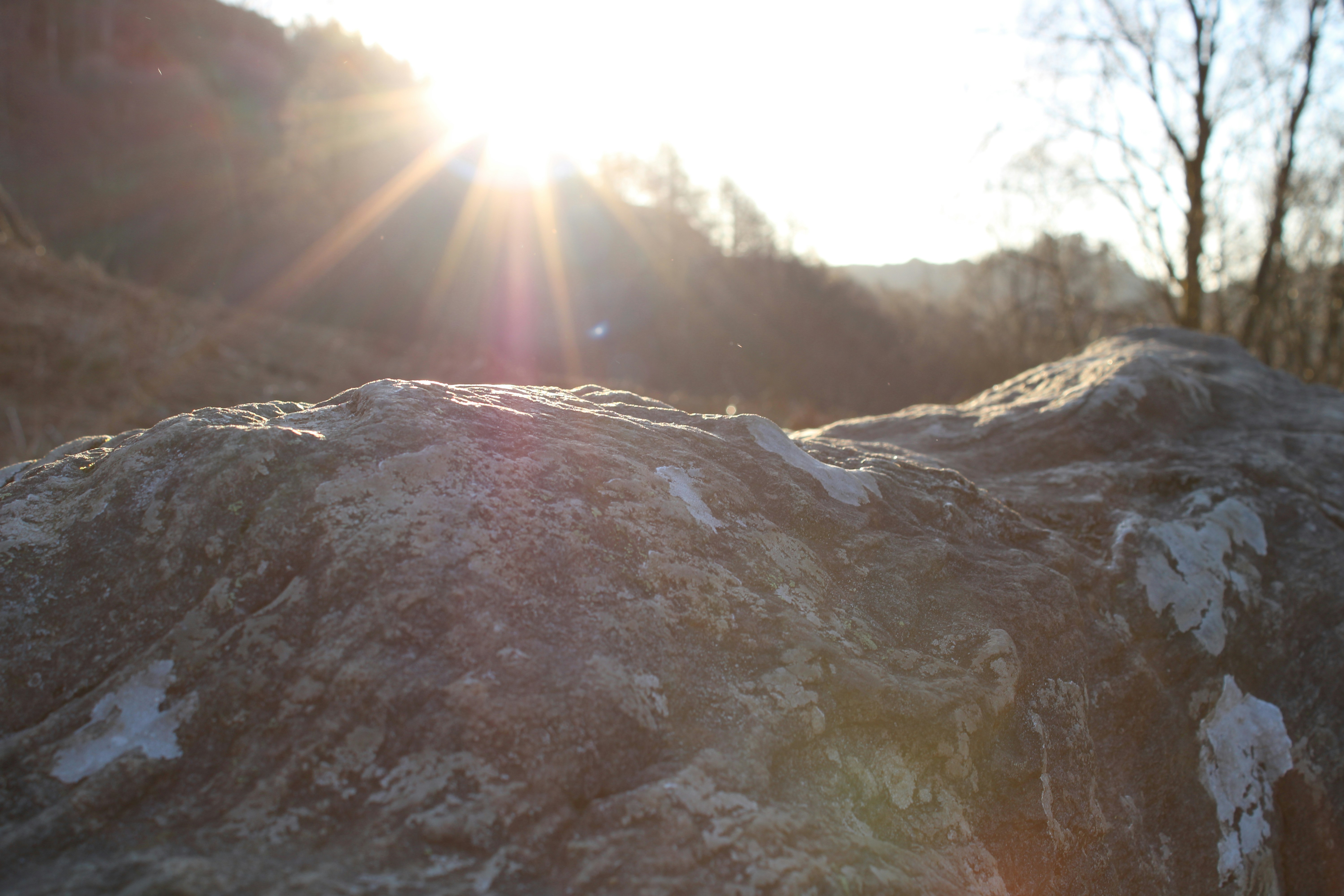 Dawn on Weathered Granite: Light Sparks Over a Quiet Rock Ridge