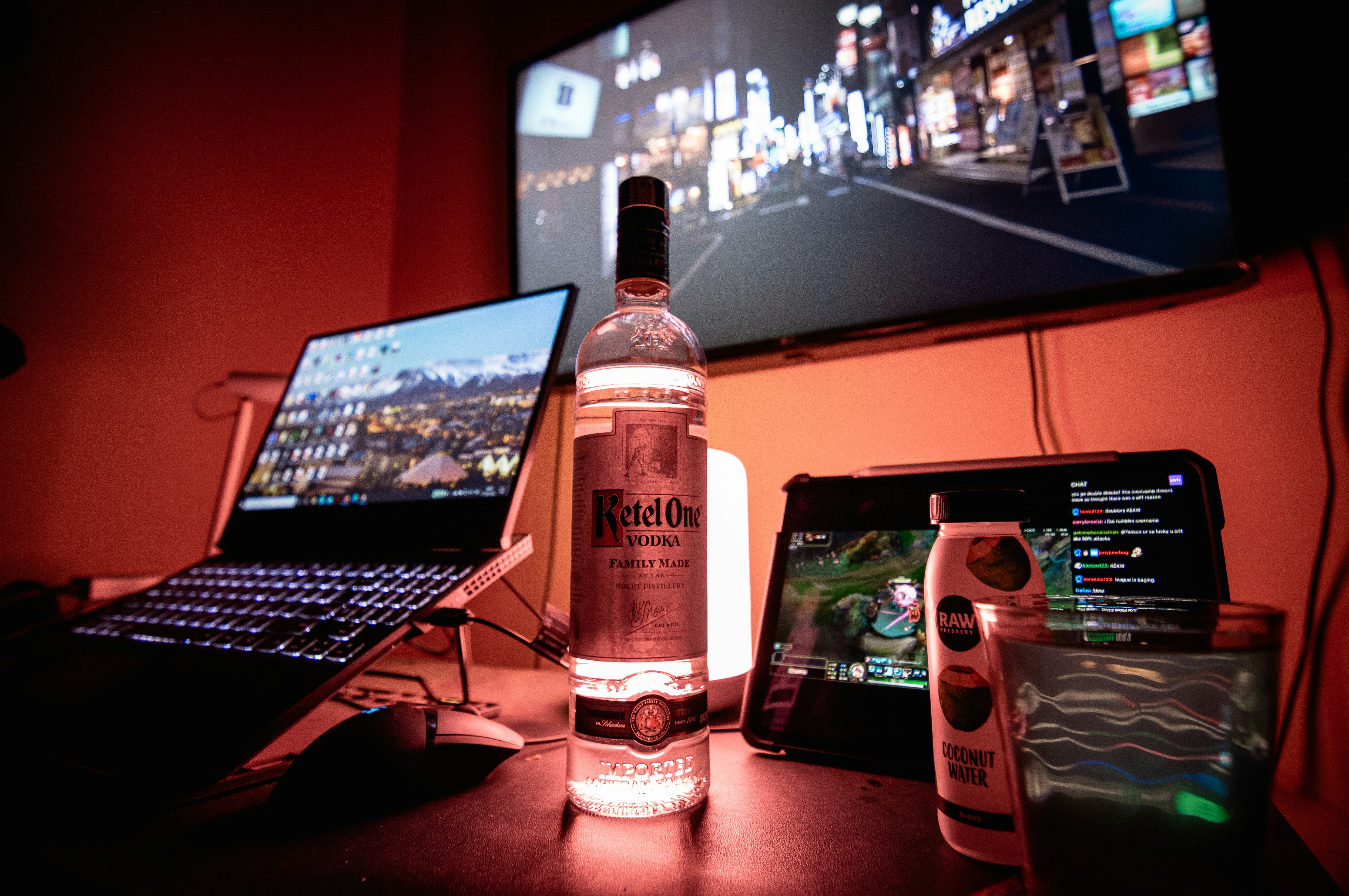 Black laptop computer beside brown and white labeled bottle photo ...