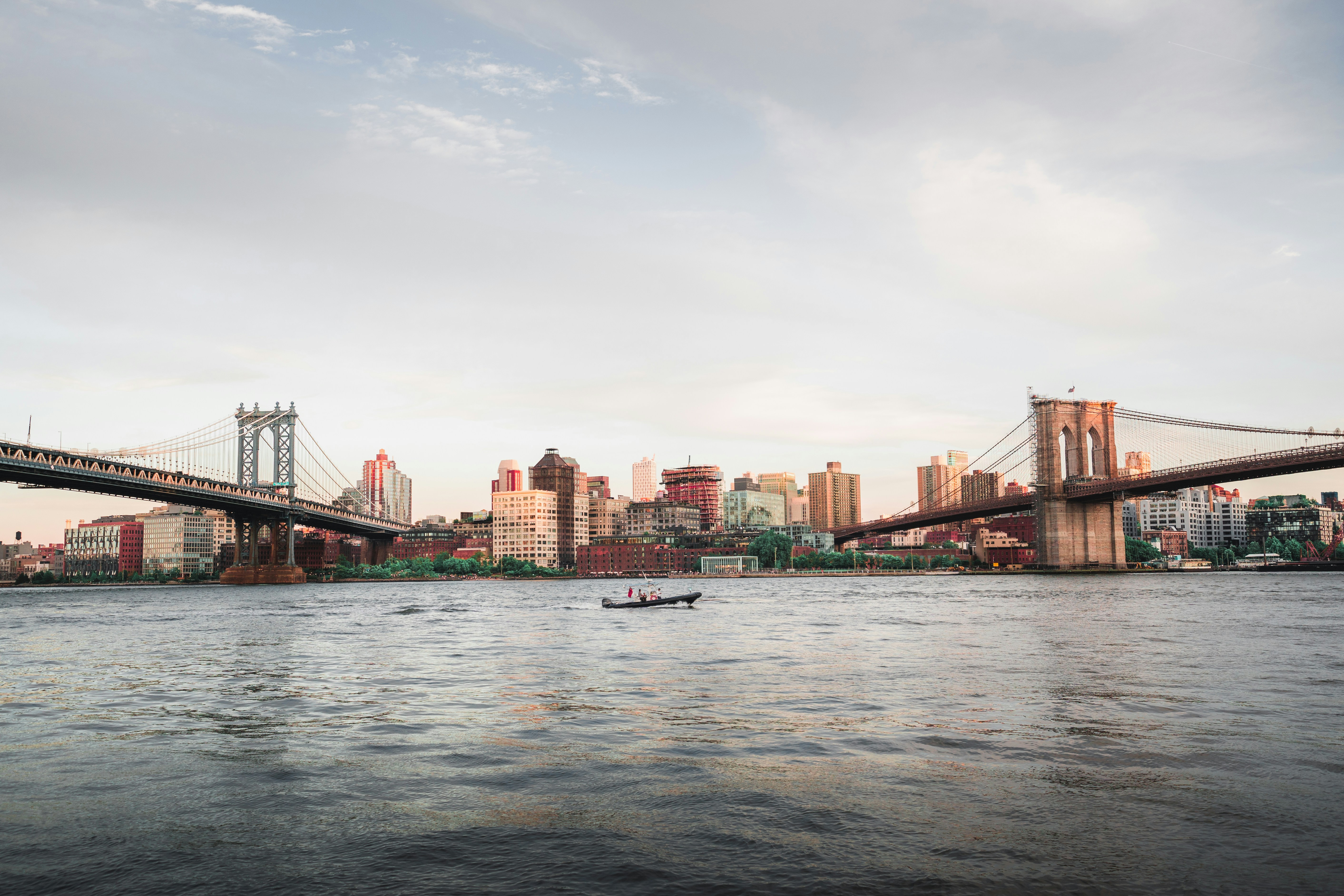 City on the Horizon: A Boat Between Bridges at Dusk