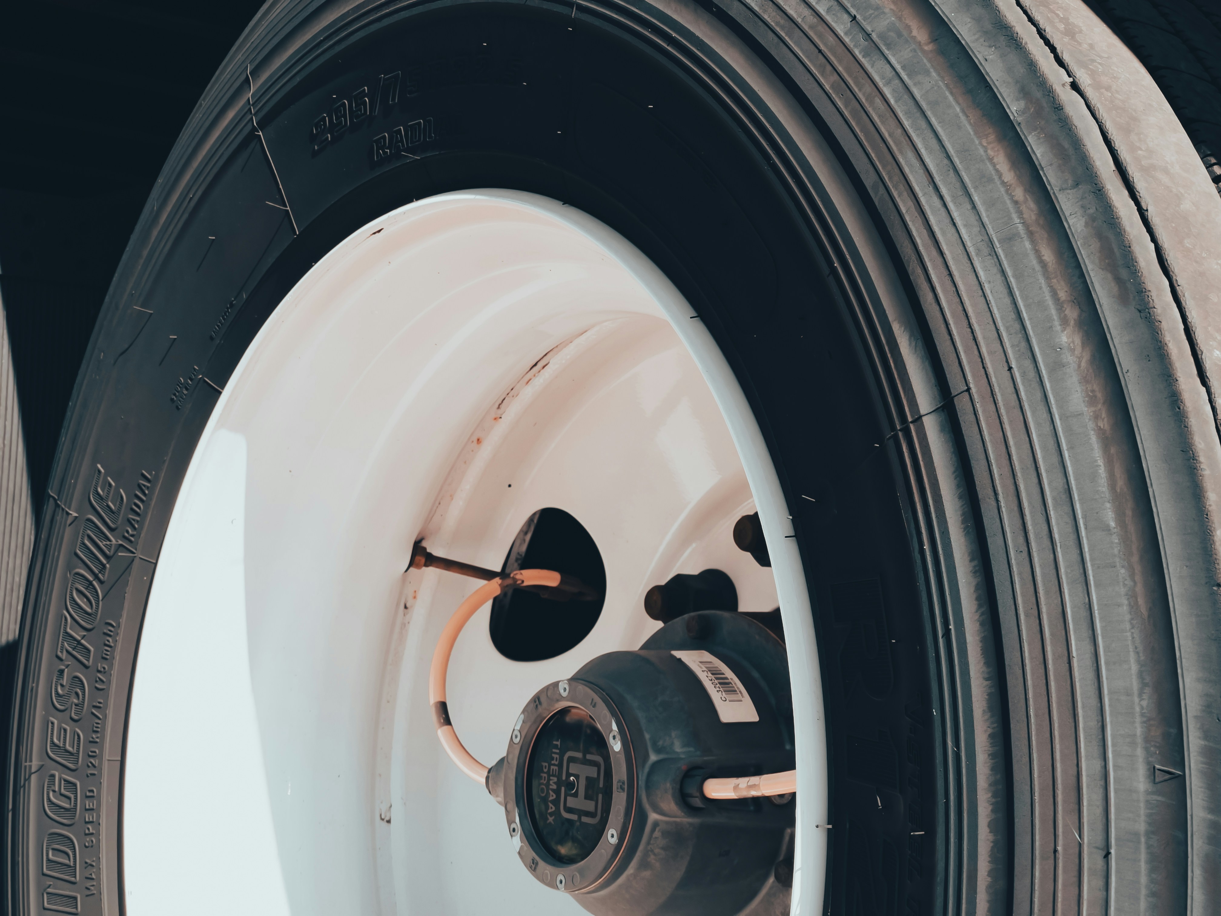 Close-up of a vehicle tire and wheel, highlighting the intricate details of the hub and tread.