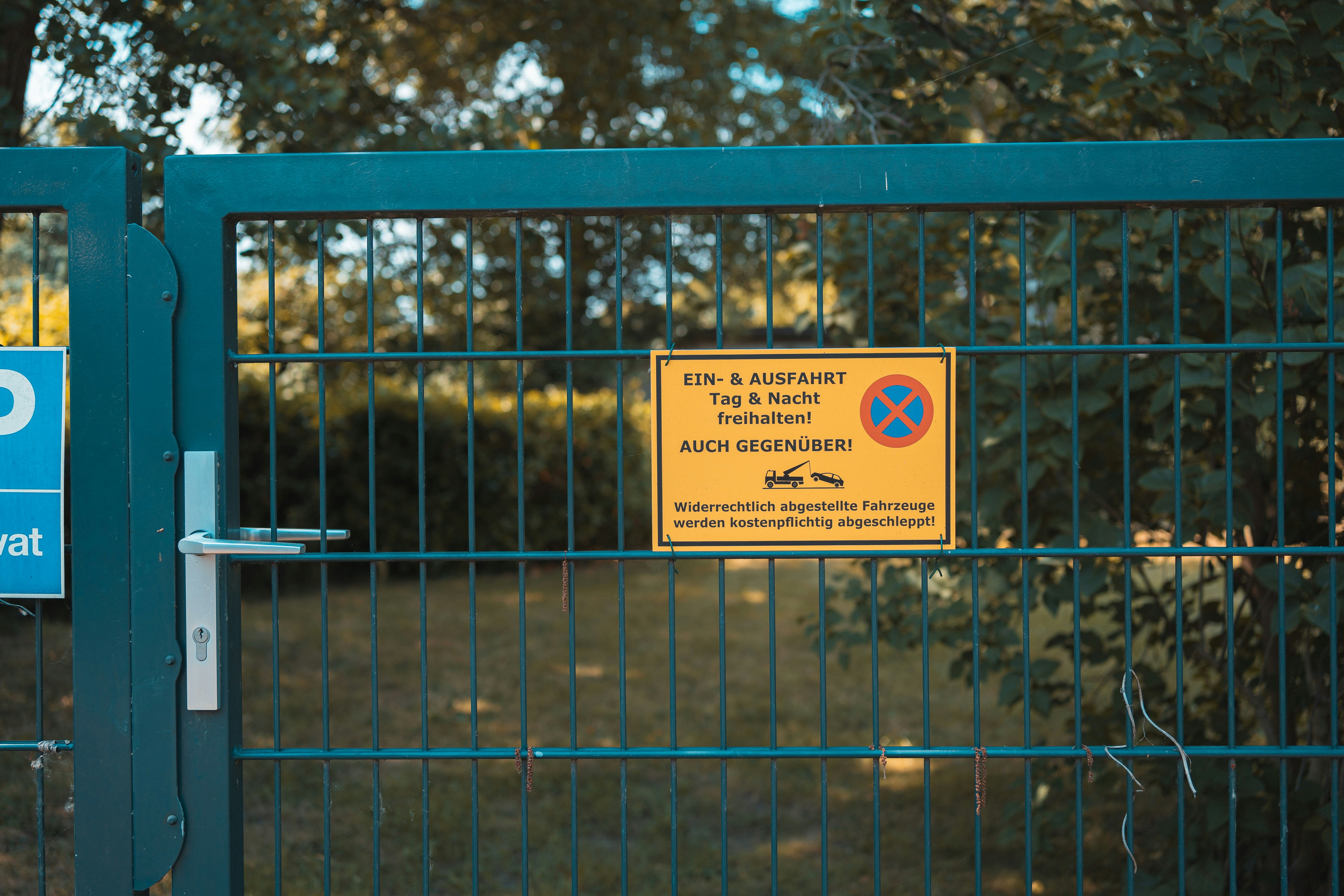 Blue metal fence with white and blue signage photo – Free Gate Image on ...