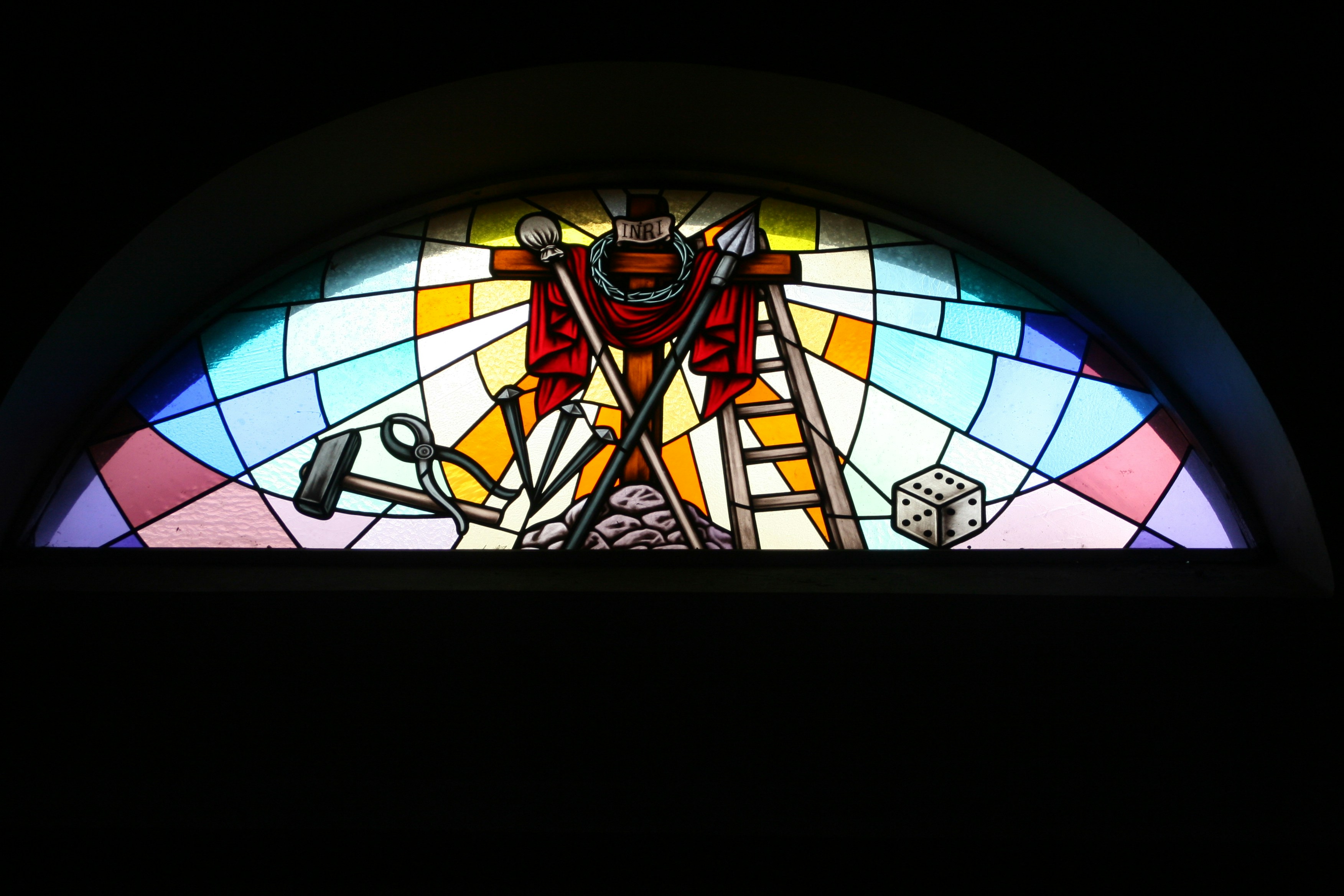 Stained-Glass Window Framing a Clerical Figure with Dice