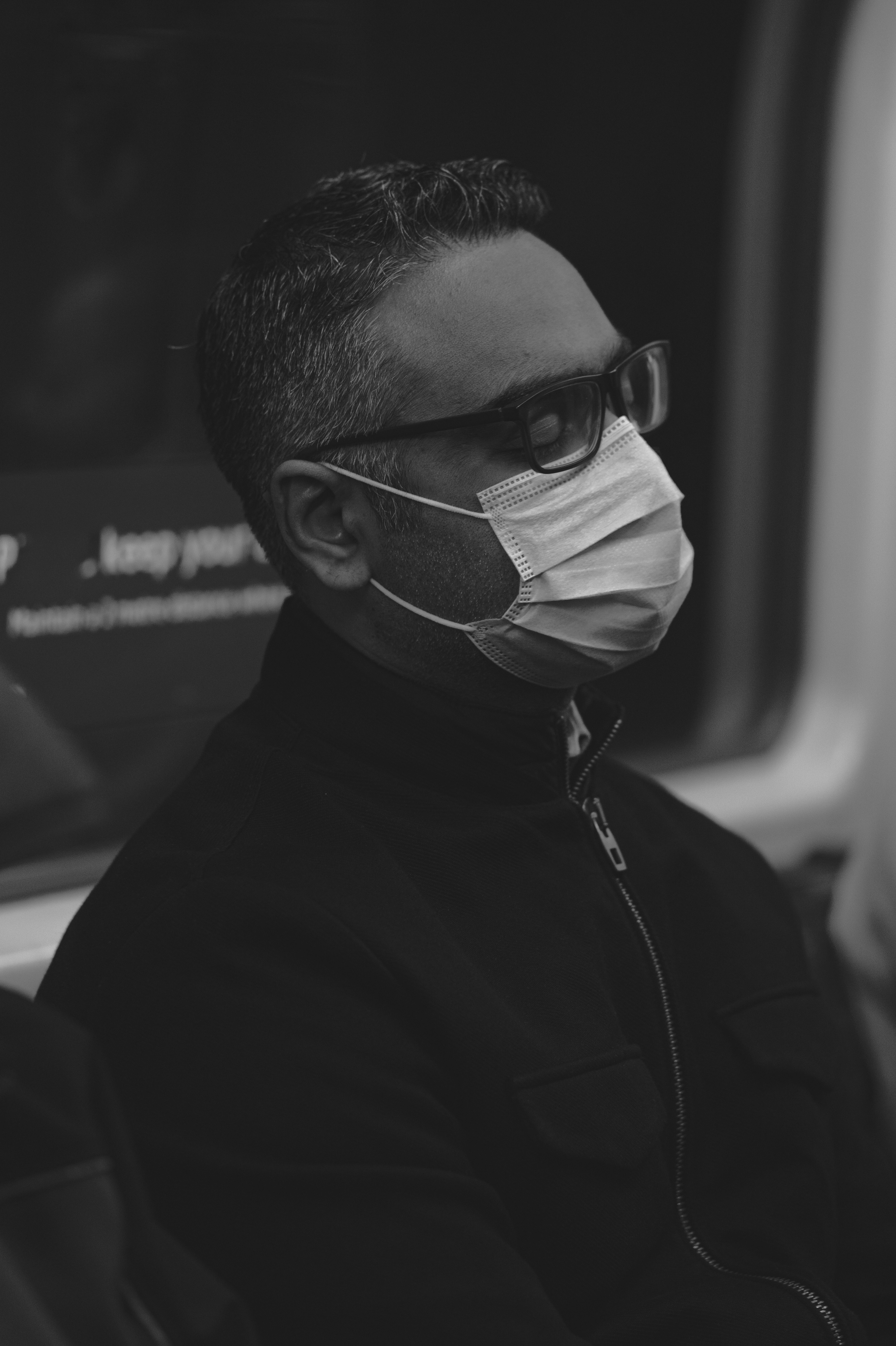 Masked Focus on the Move: A Quiet Portrait on the Rail