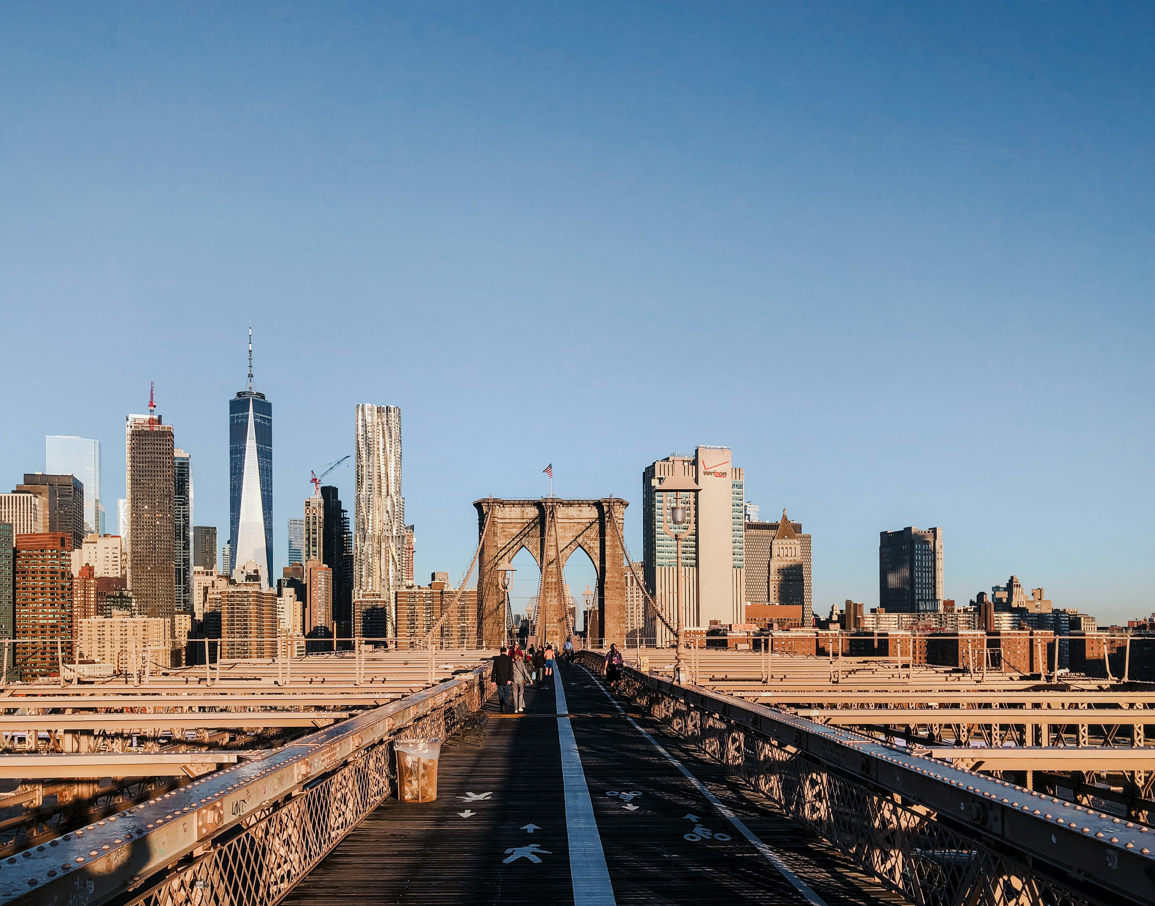 bridge over body of water near city buildings during daytime