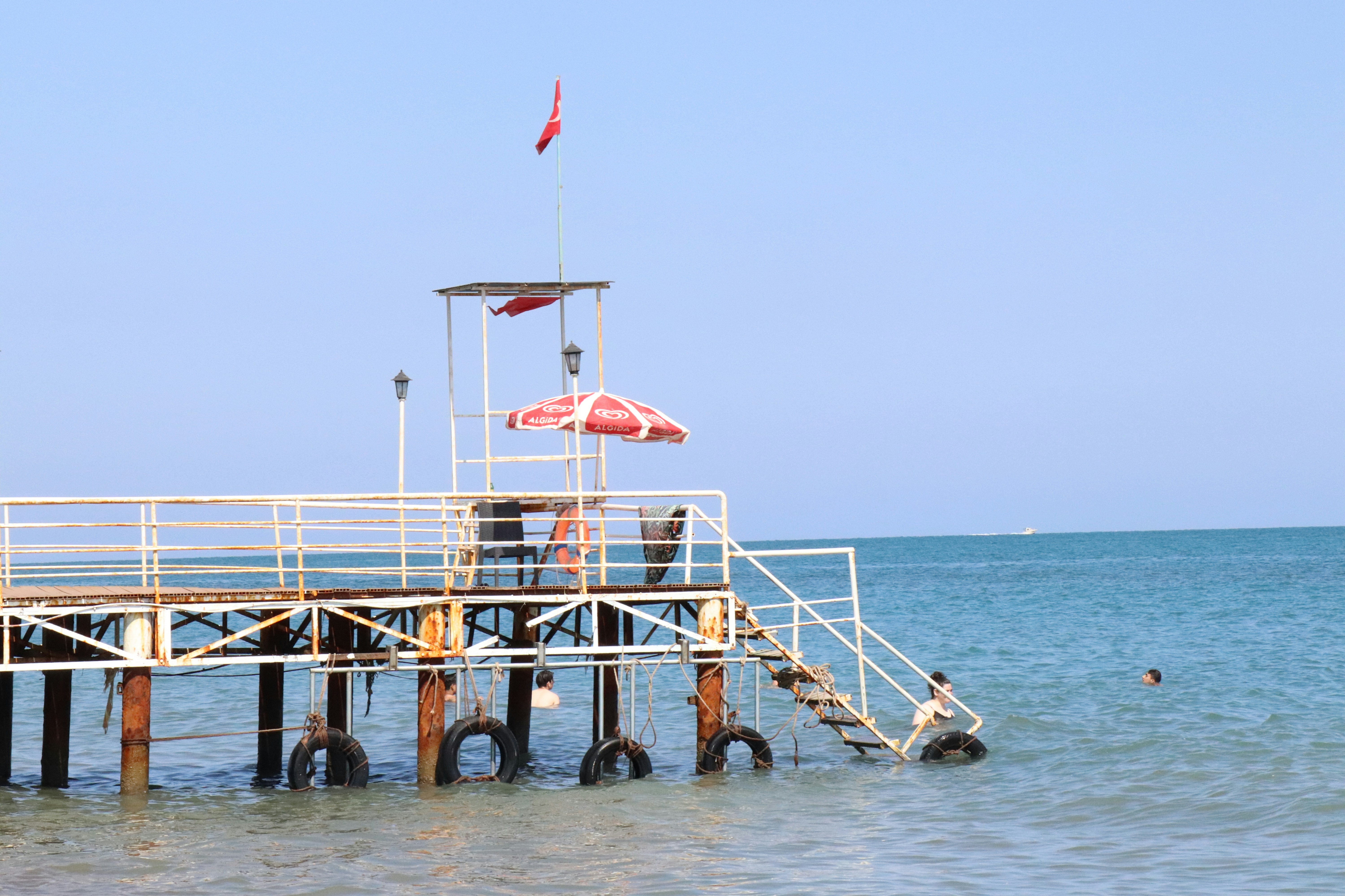 people on brown wooden dock on sea during daytime