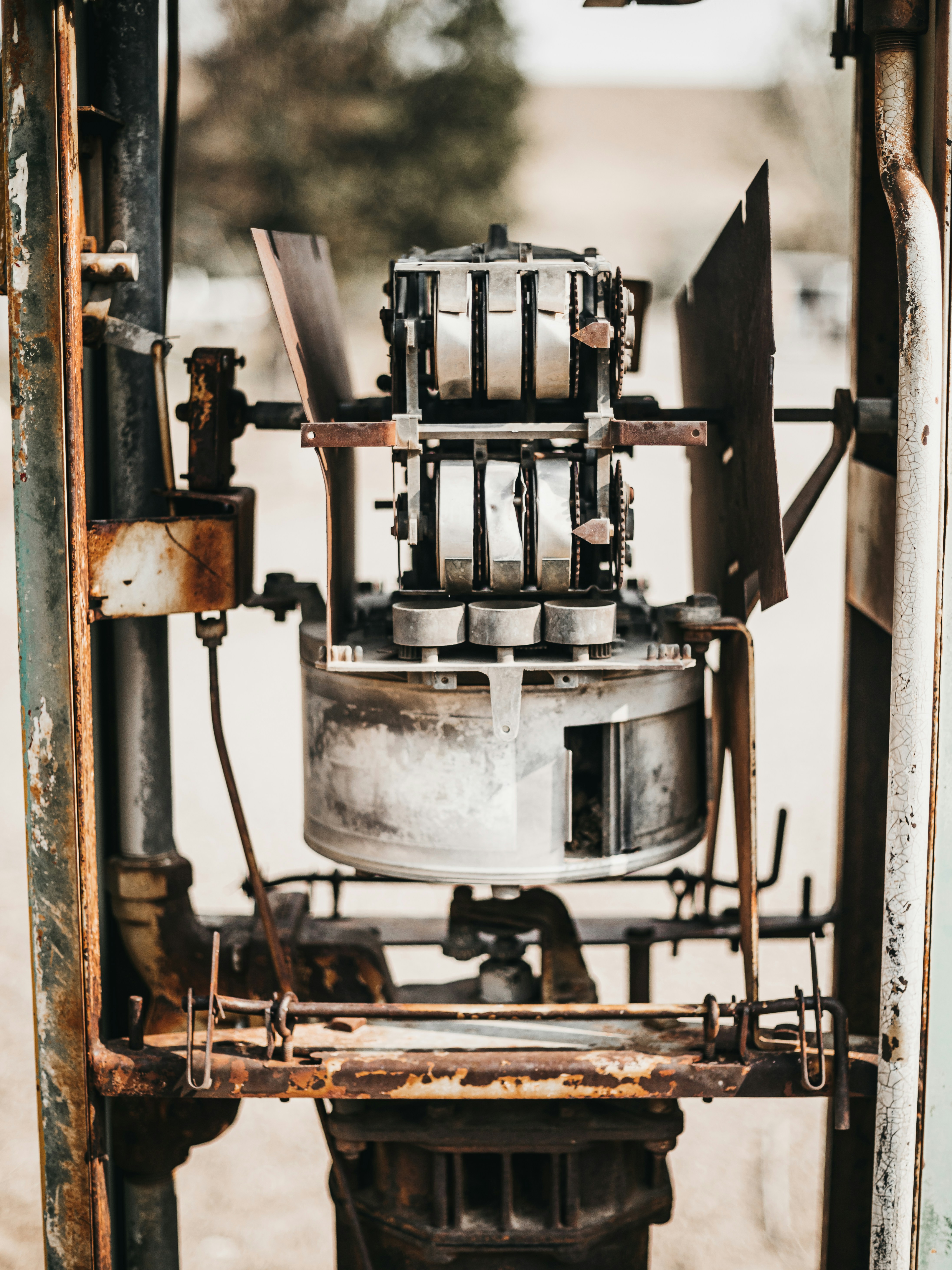 Intricate internal workings of an antique machine, showcasing rusted metal components and mechanical design.