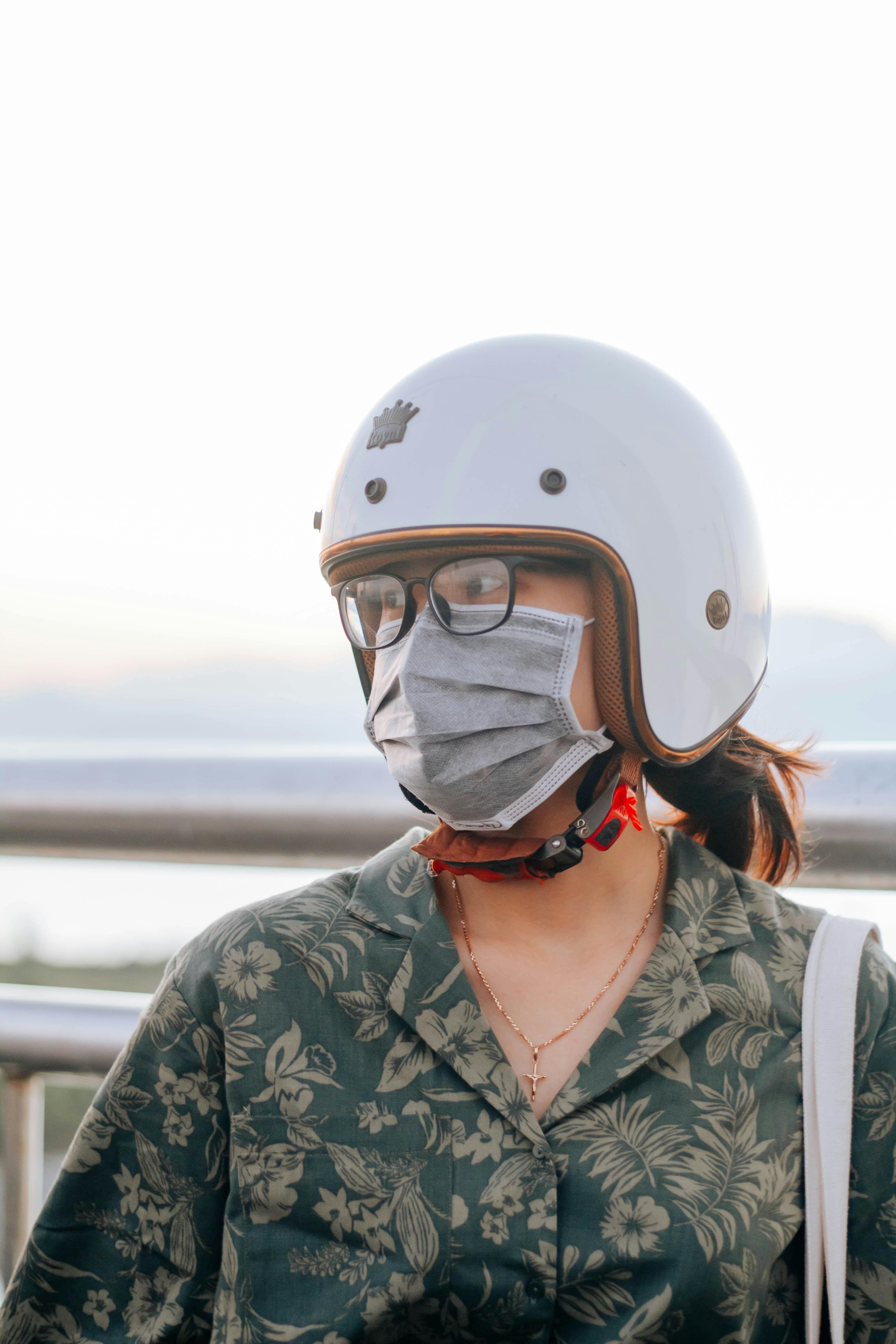 Coastal Casual: Masked Rider in a Floral Shirt at Sunset Promenade