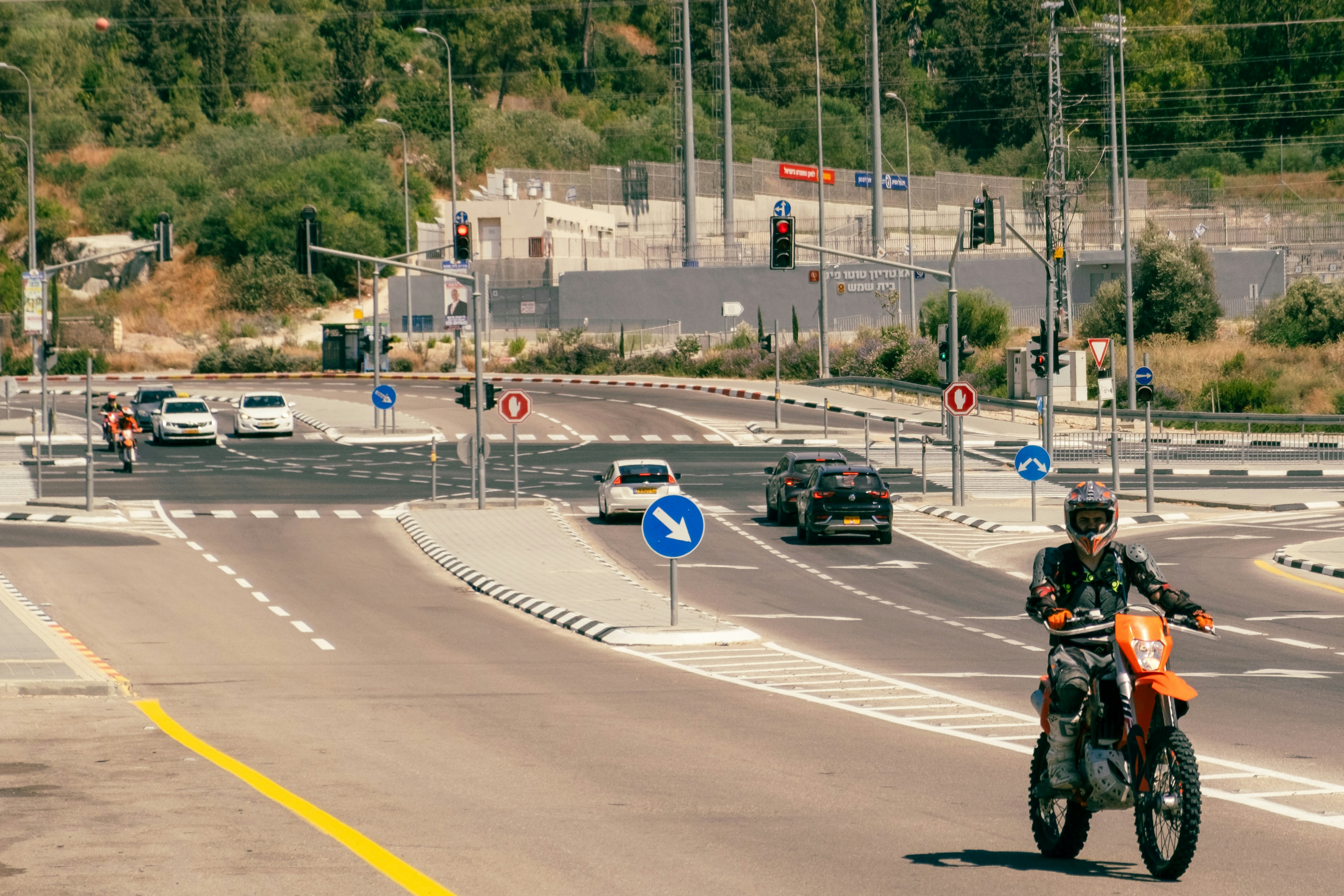 Orange Moto at the City Roundabout: A Moment of Motion at the Intersection