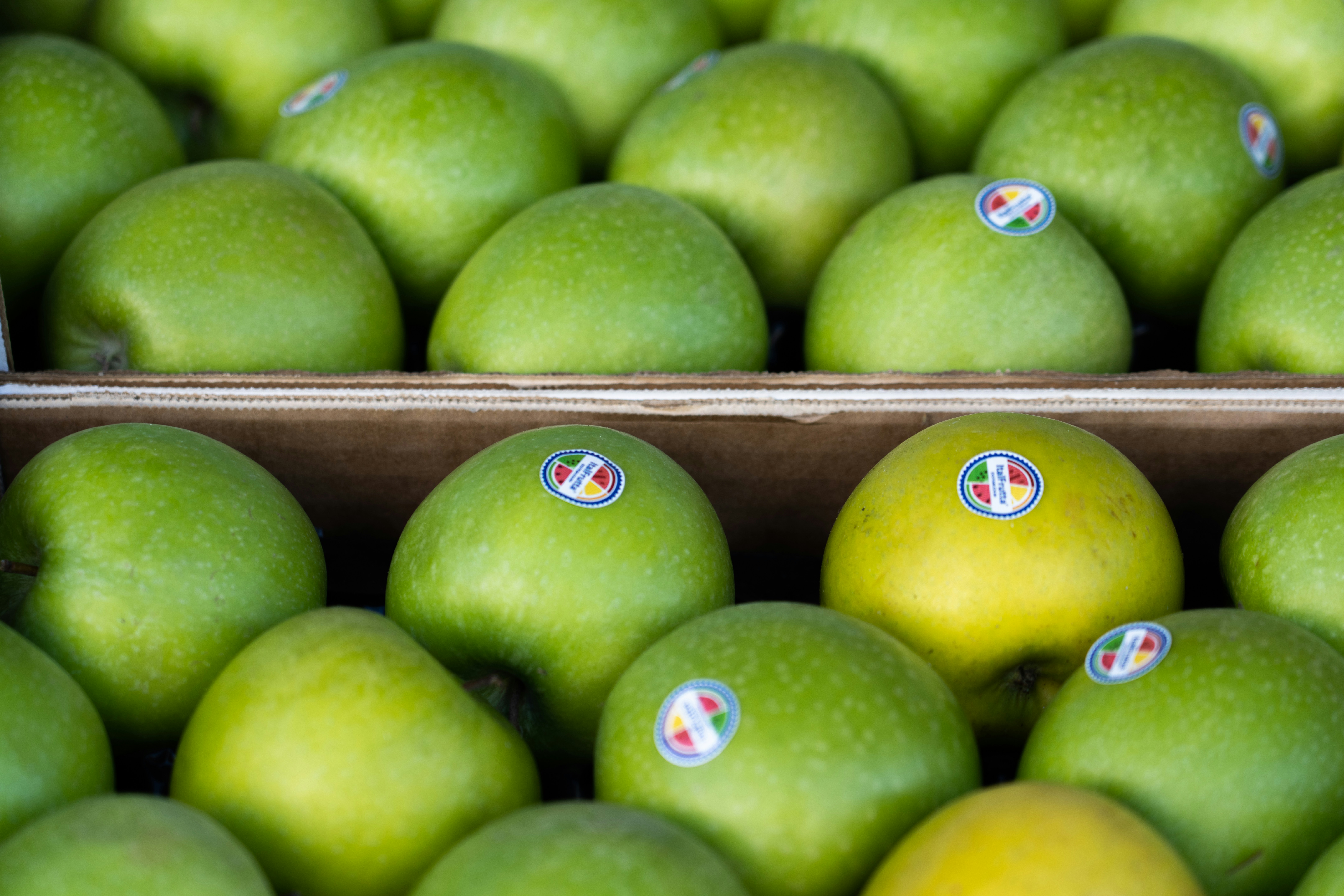 green apples in brown wooden crate