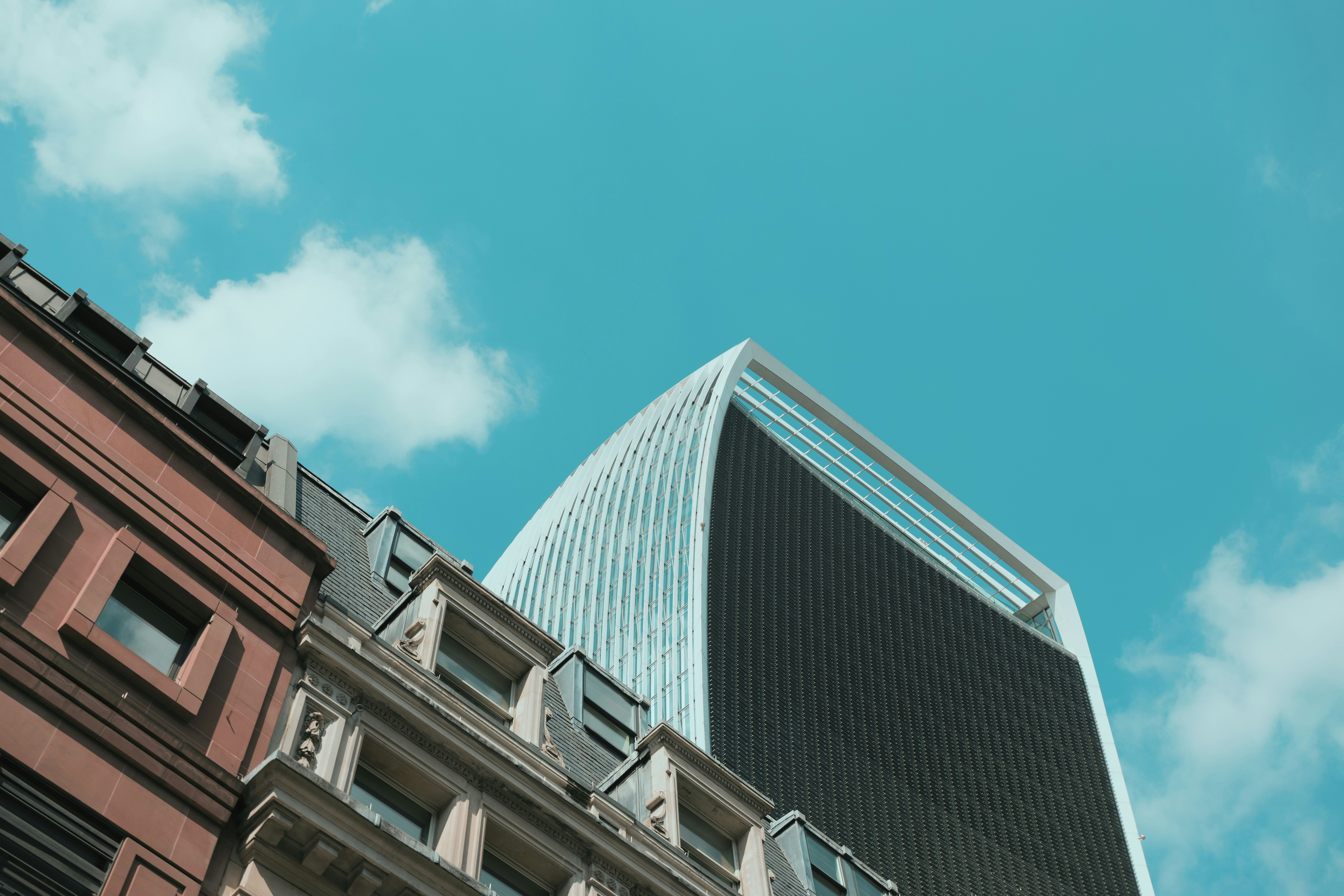 Arc of Glass Over Brick Facades: A Modern Tower Dominates the Skyline