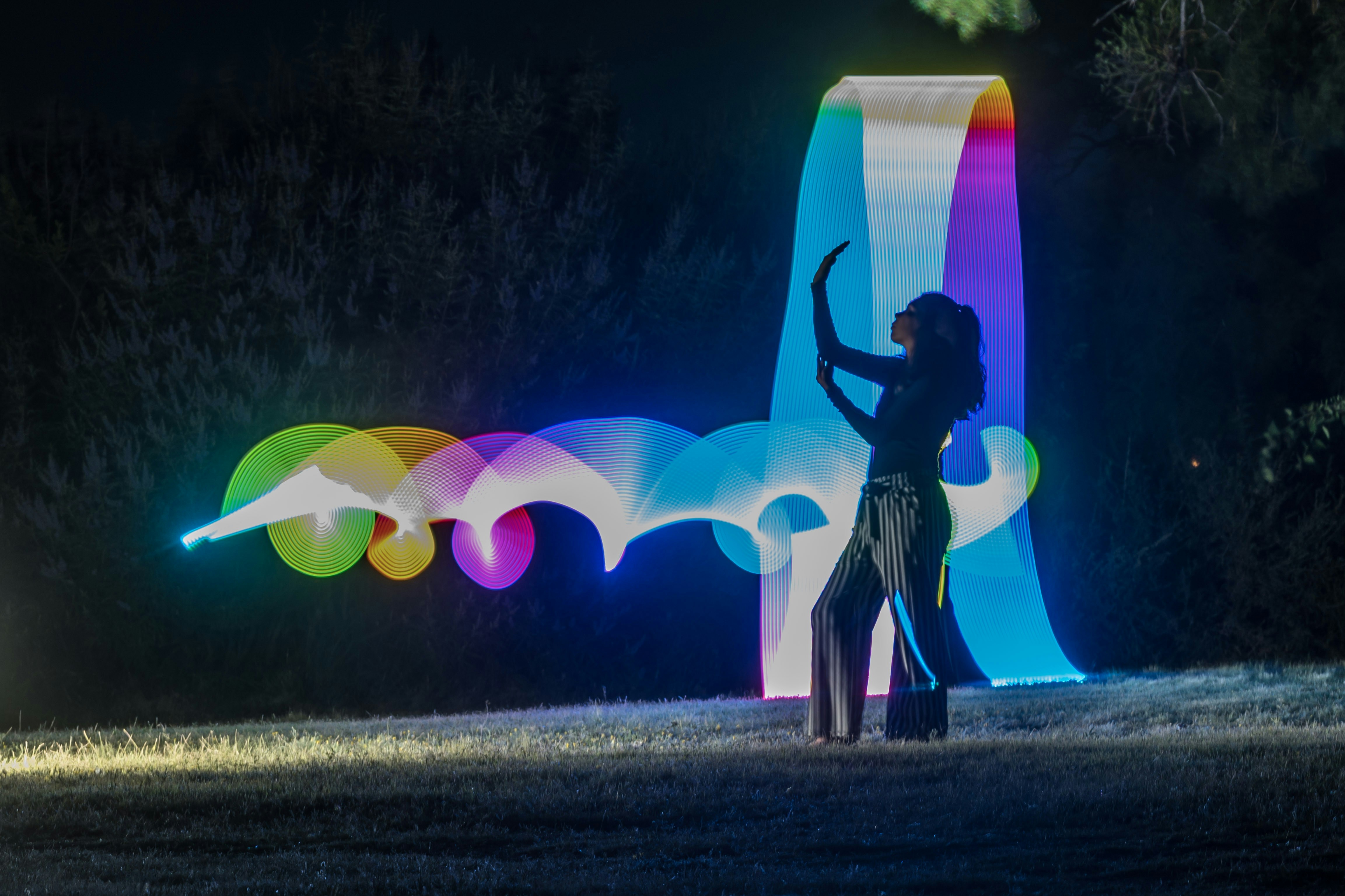 Neon Ribbon Dance Under Night-Glow Arcs