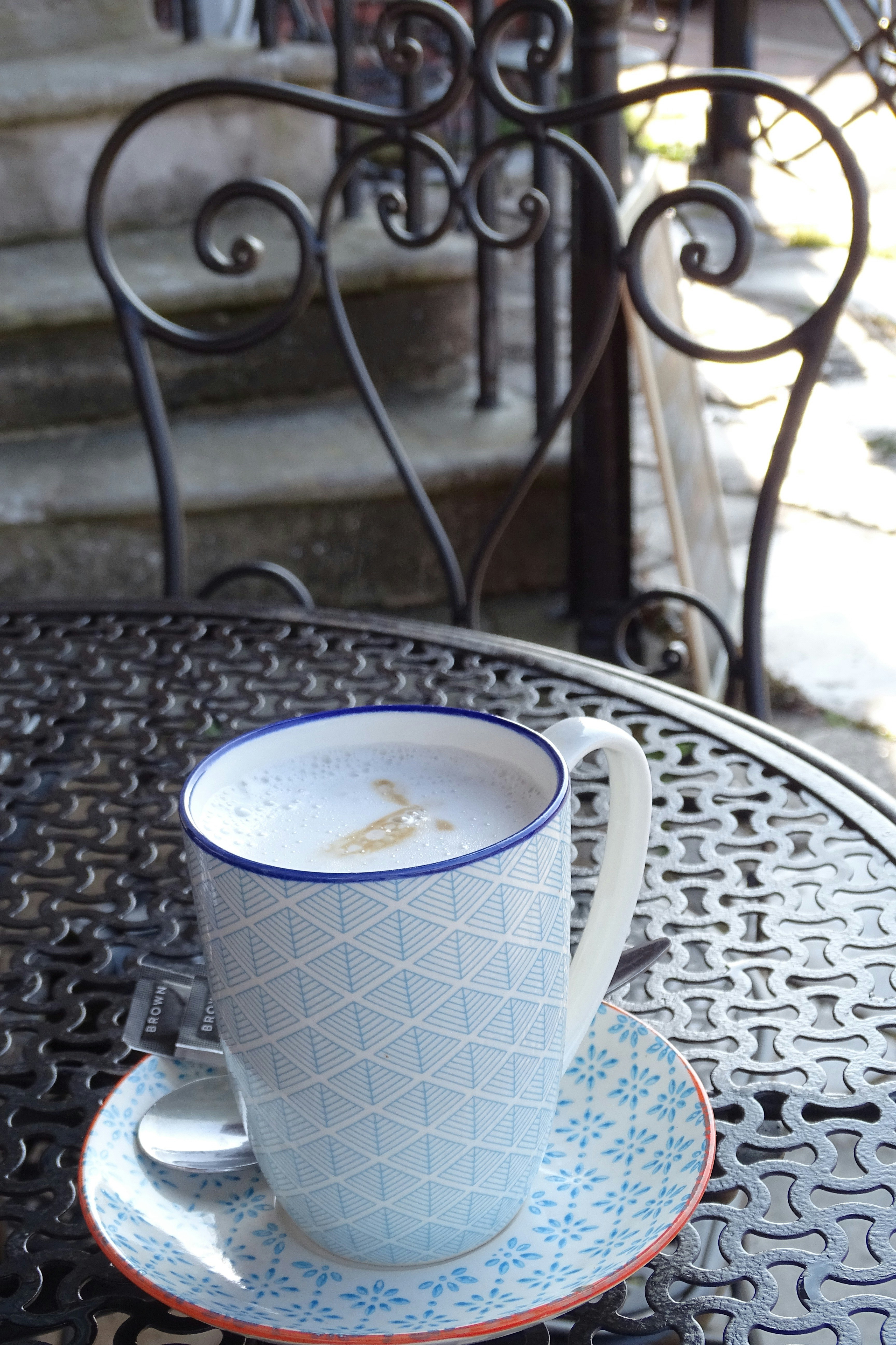 Blue-Geometric Mug on a Lattice Table: Quiet Café Morning