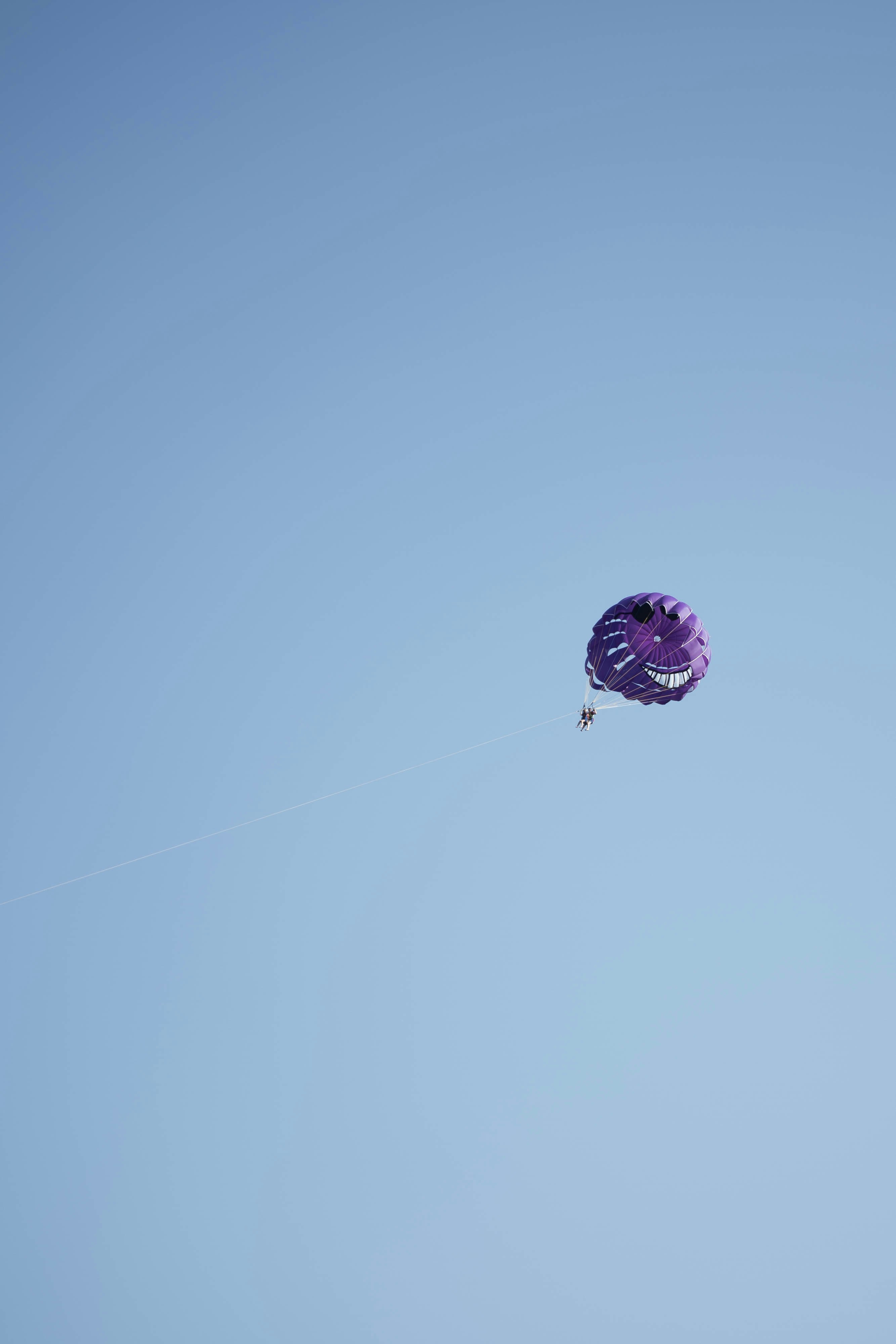 Purple Parasail Drifts Across a Quiet Ultramarine Sky