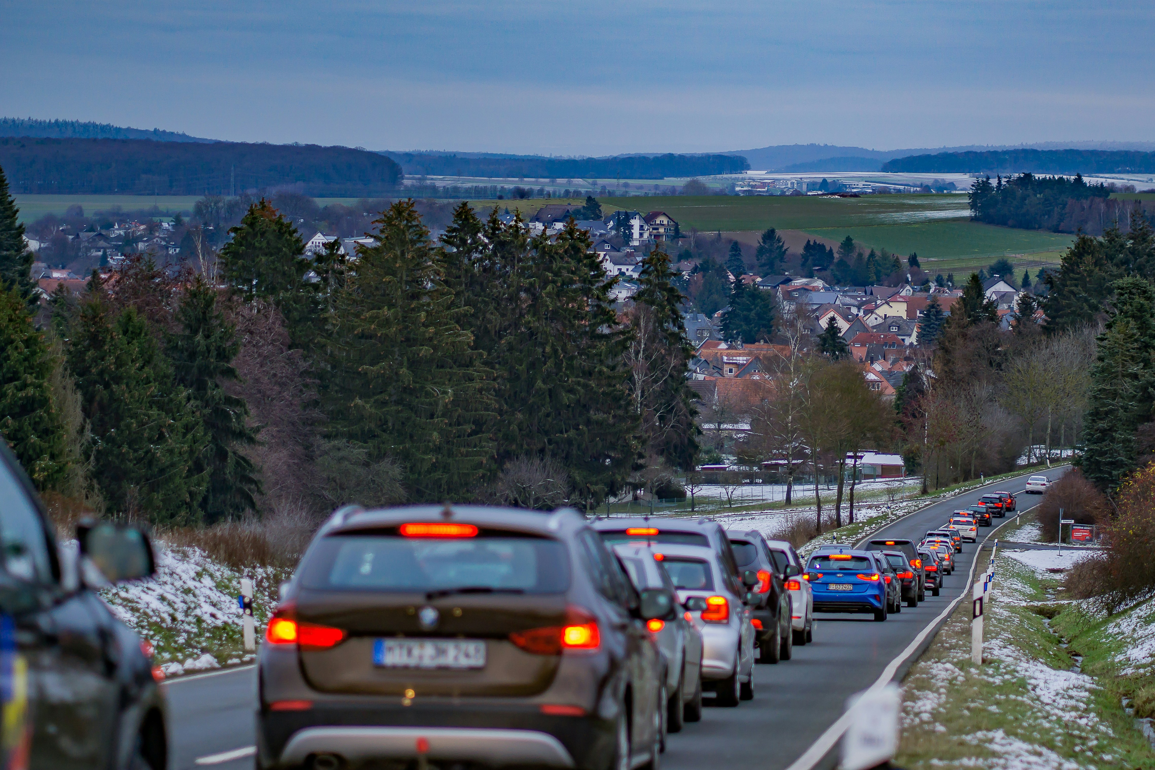 Queue on the Winter Ridge: A Snow-Burnished Drive Through a Suburban Landscape