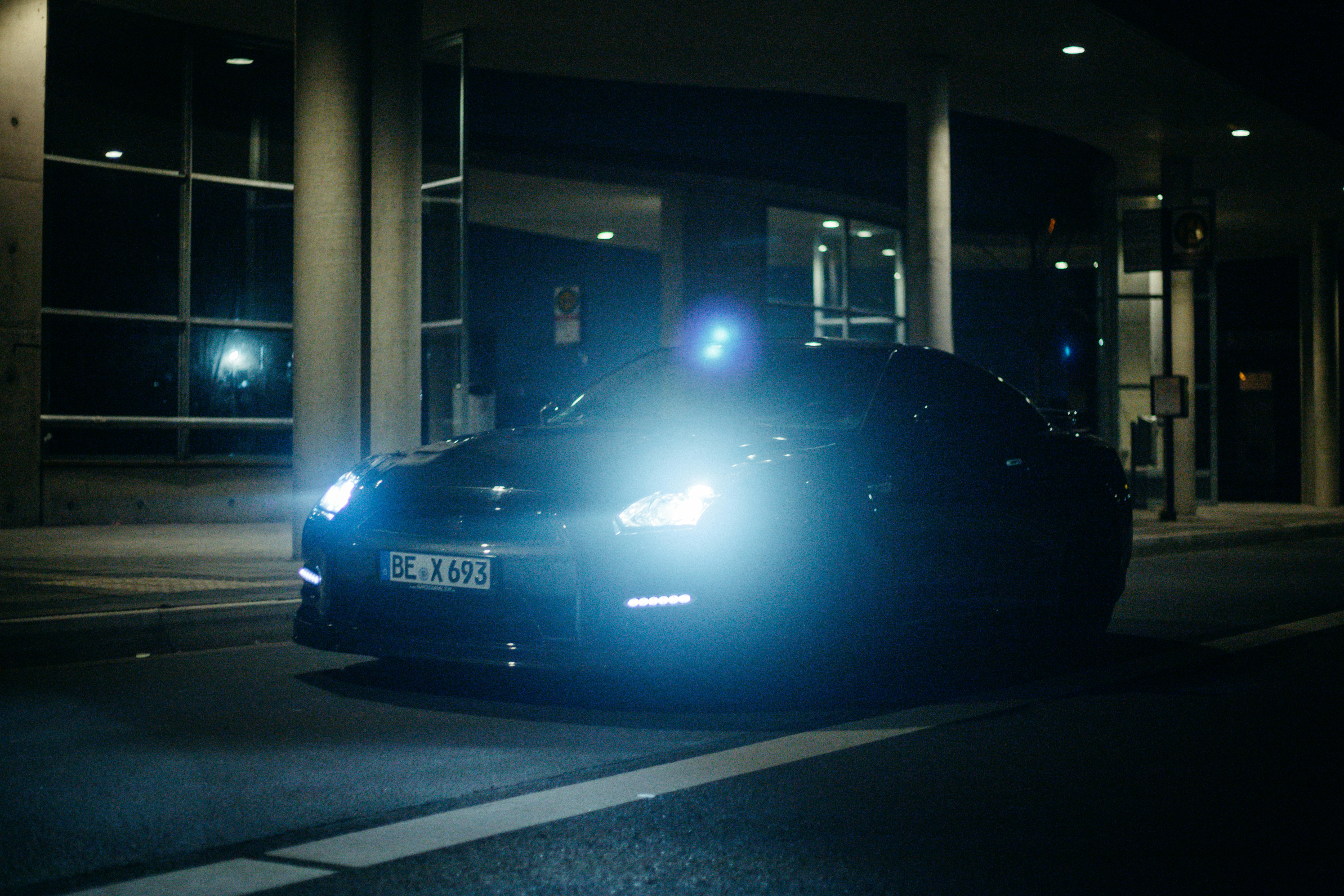 Nissan GT-R R35 at a bus stop in Germany at nighttime.