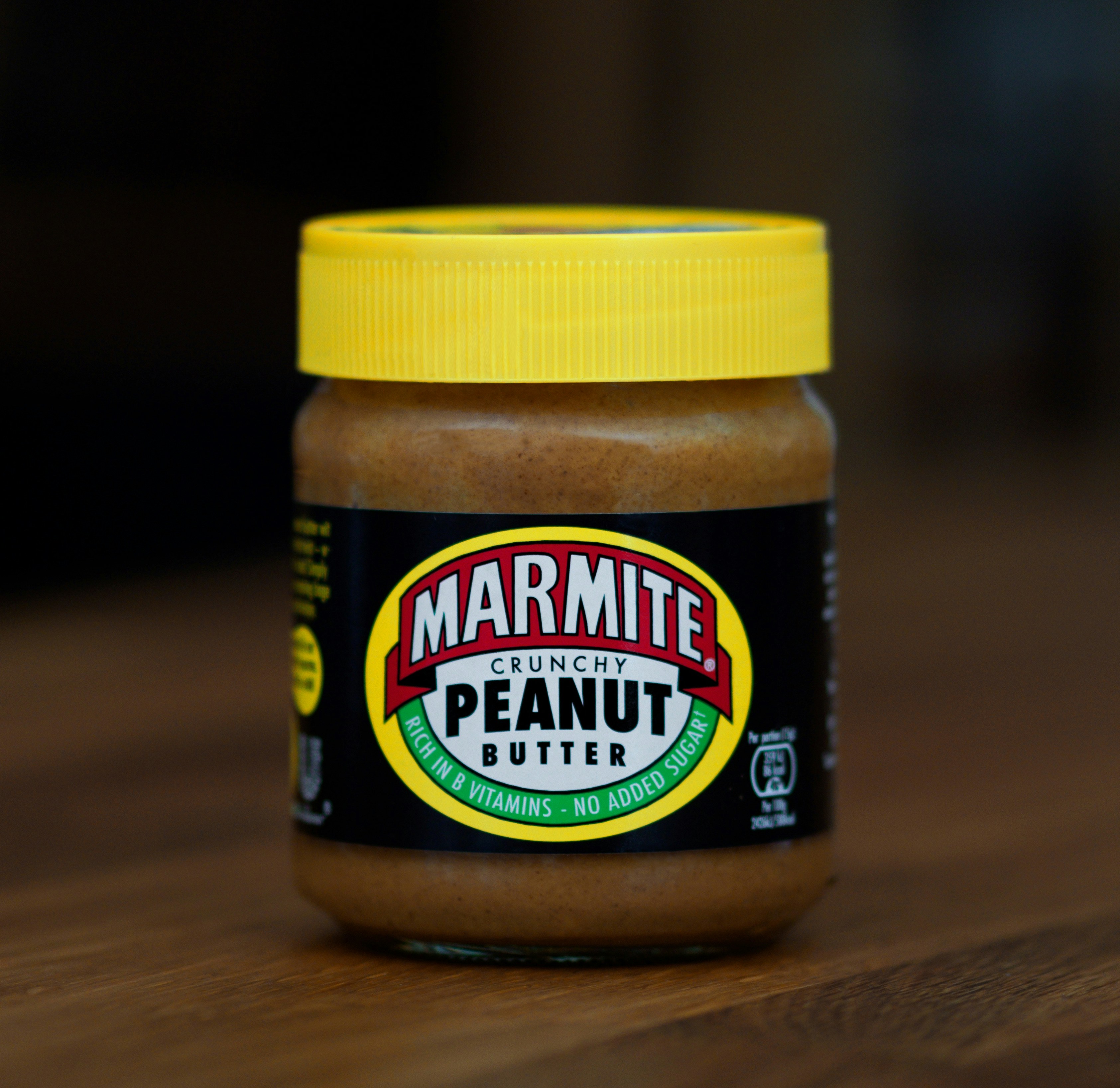 Label in Focus: A Jar of Marmite Peanut Butter Quiet on a Wooden Stage