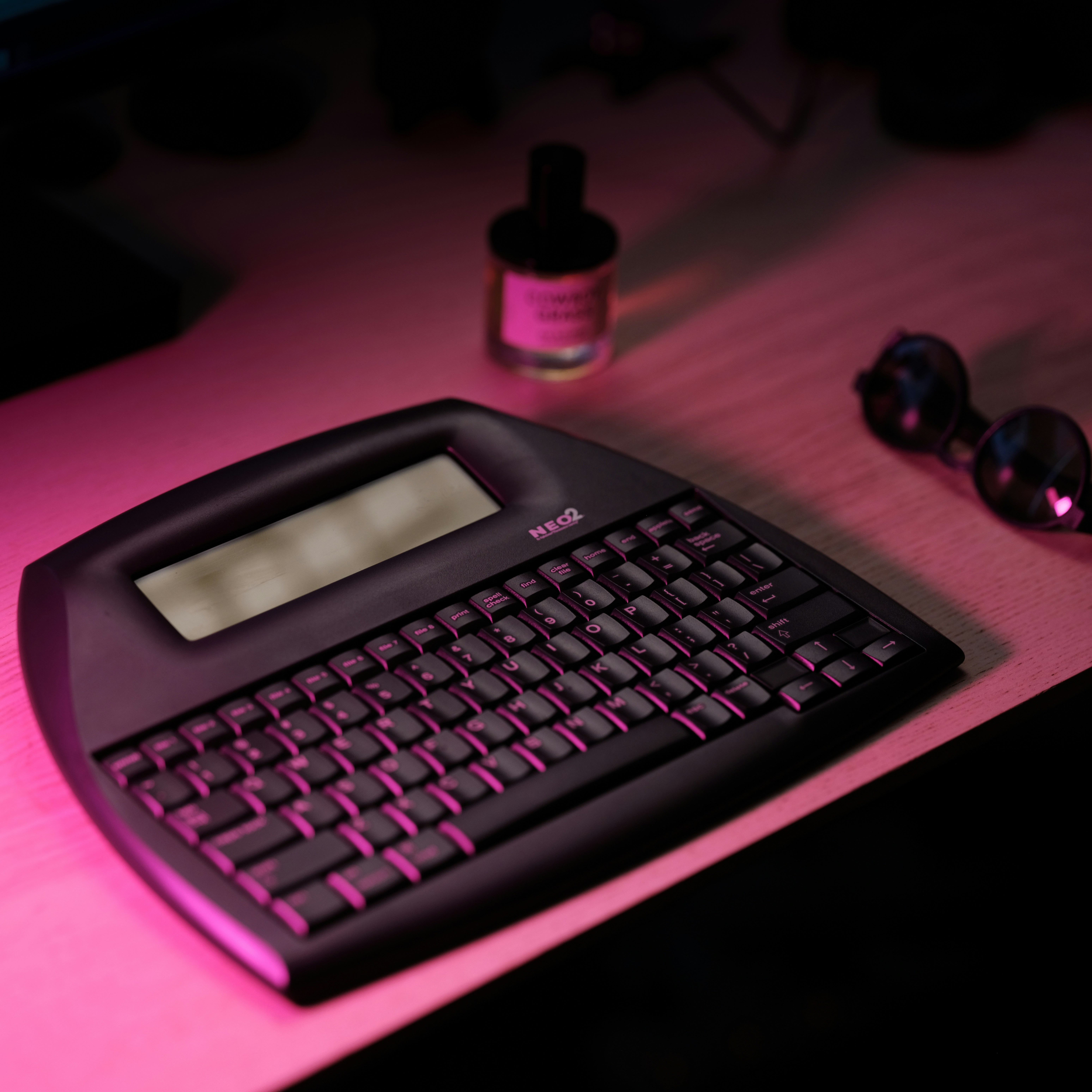 Backlit Keyboard Console Under Magenta Glow