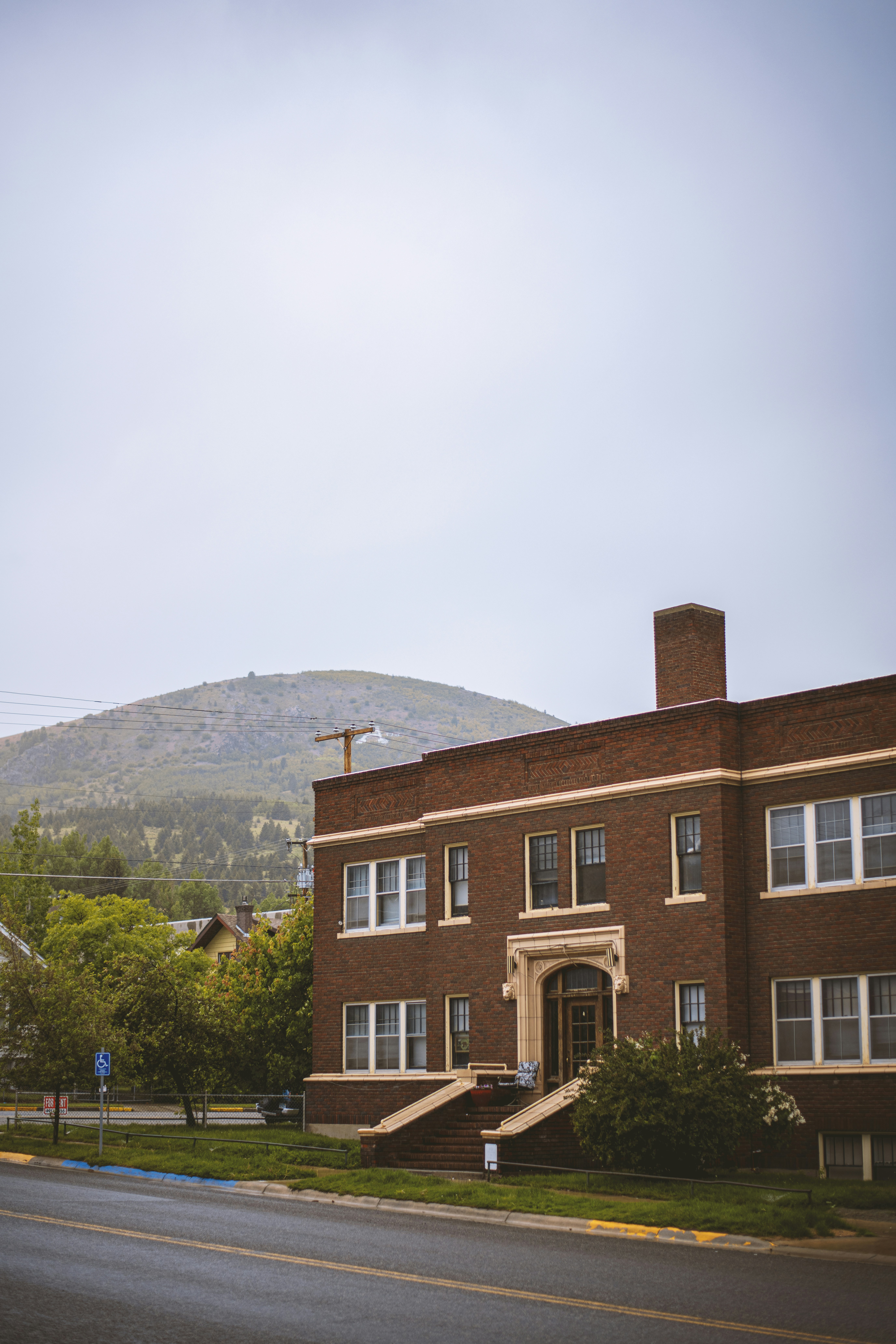 Brick Schoolhouse Framed Against a Gentle Mountain Backdrop