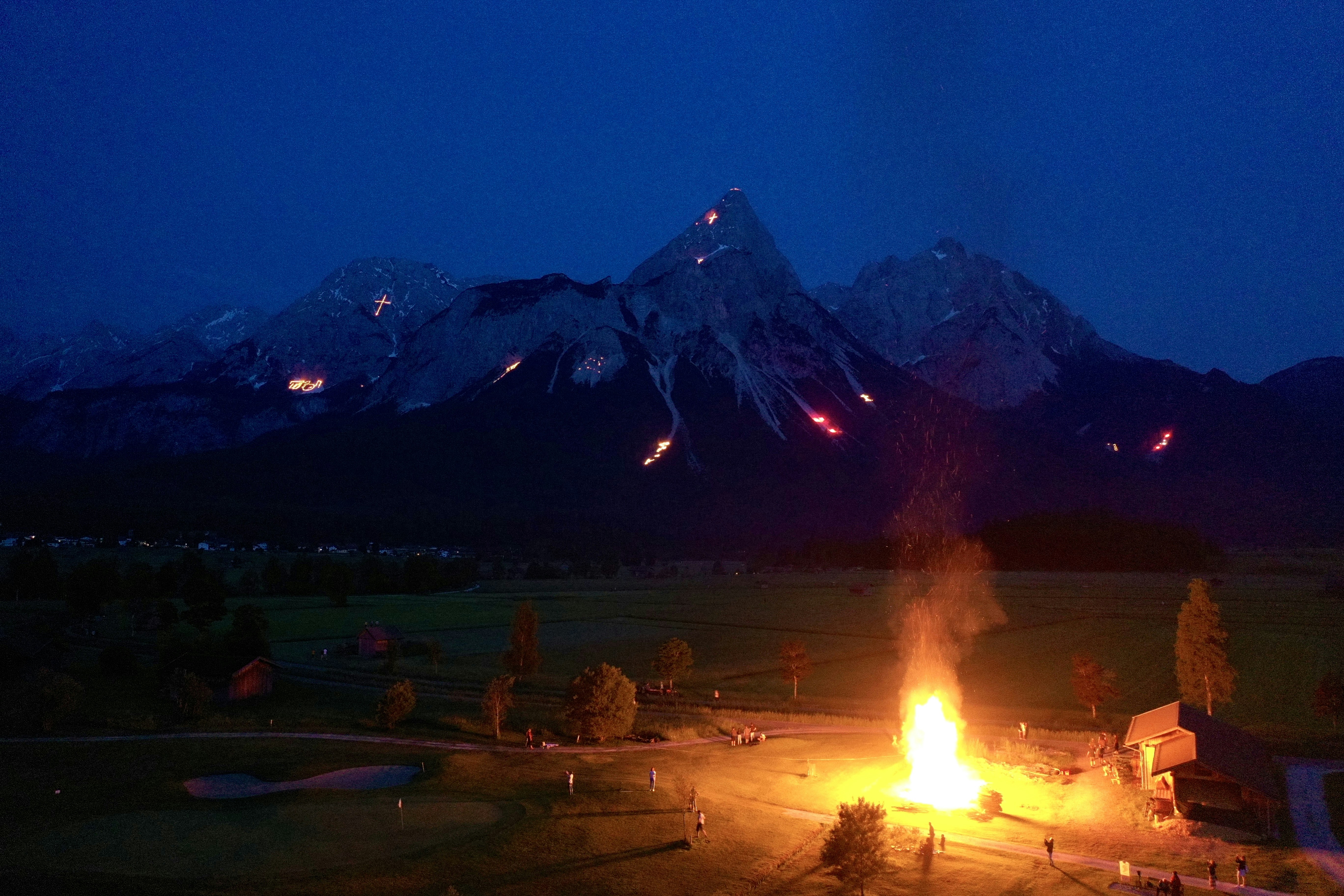 Campfire Pulse Beneath Snow-Capped Giants