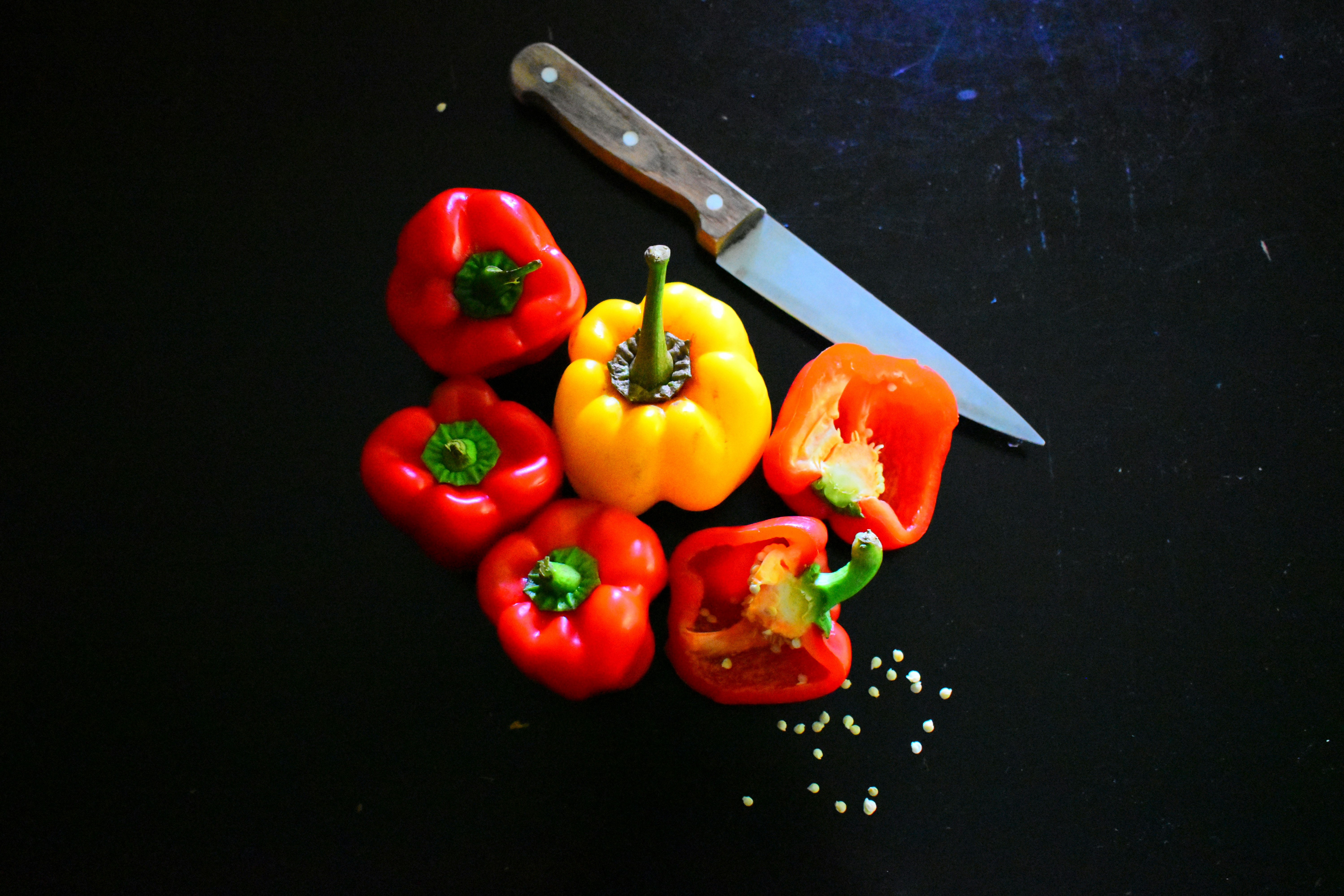 Red and orange bell peppers beside silver bread knife photo – Free Food ...