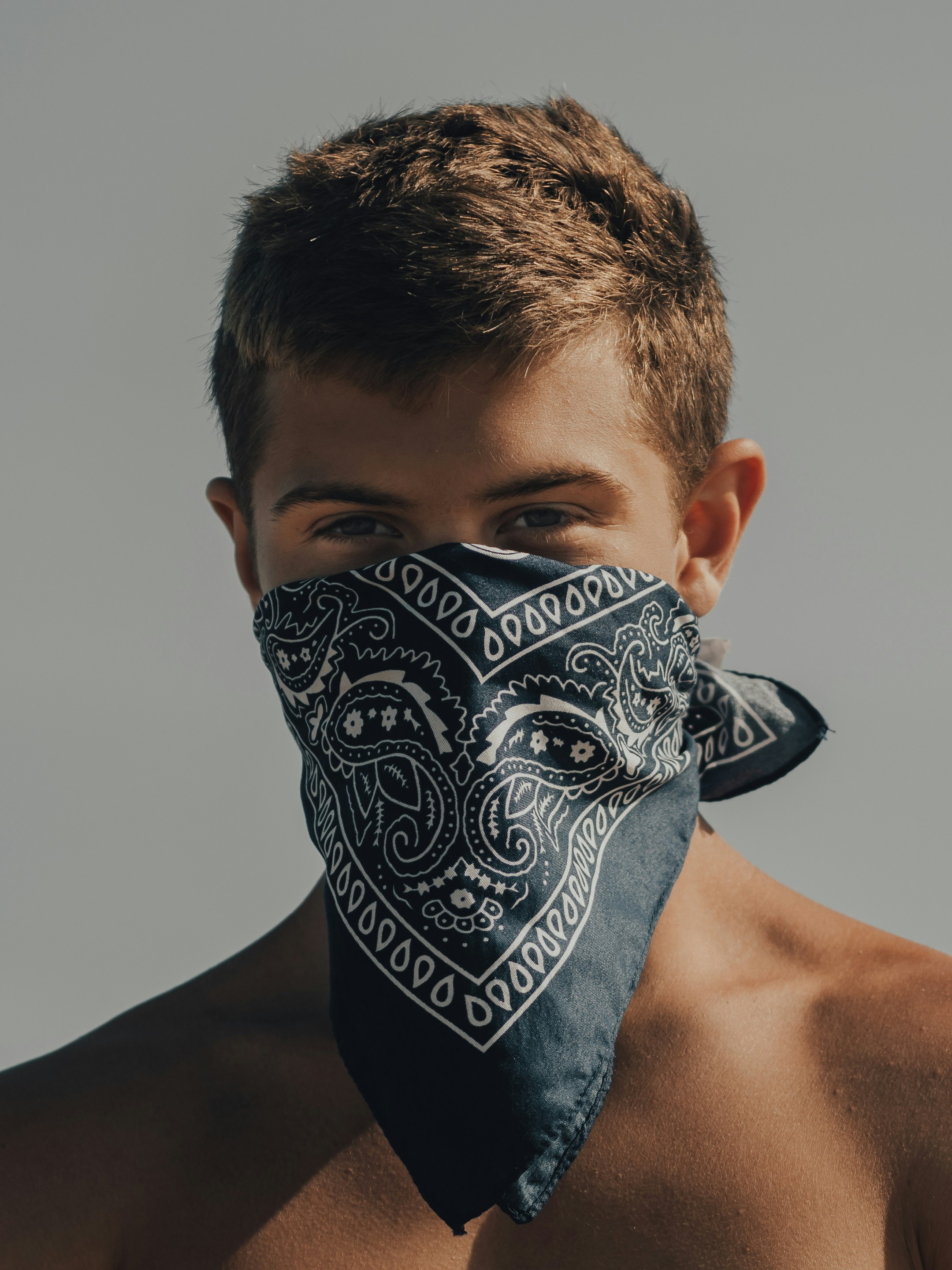 Masked Portrait: Focused Gaze Beneath a Bandana Shield
