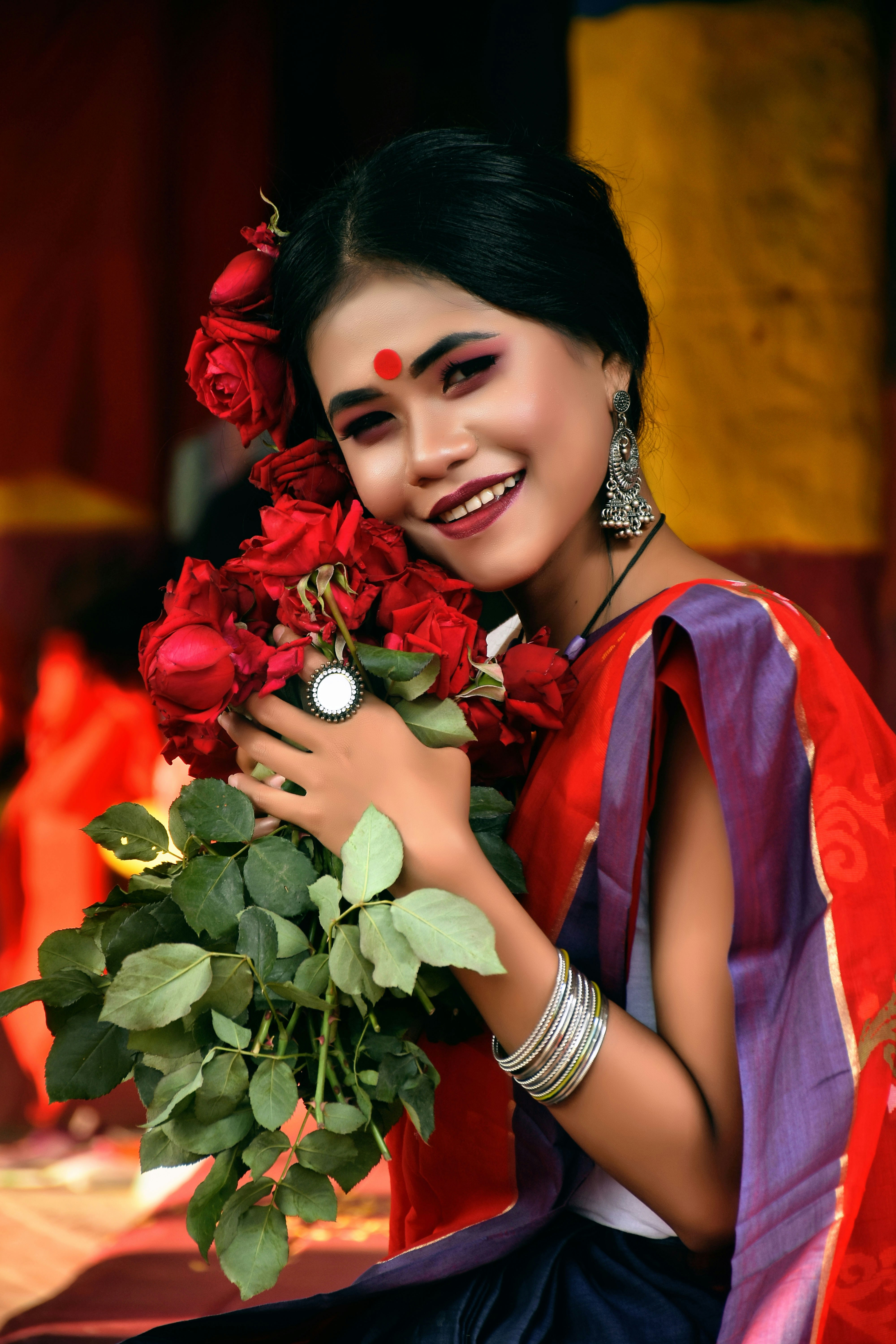Crimson Bouquet and a Radiant Smile: A Portrait in Silk and Rose